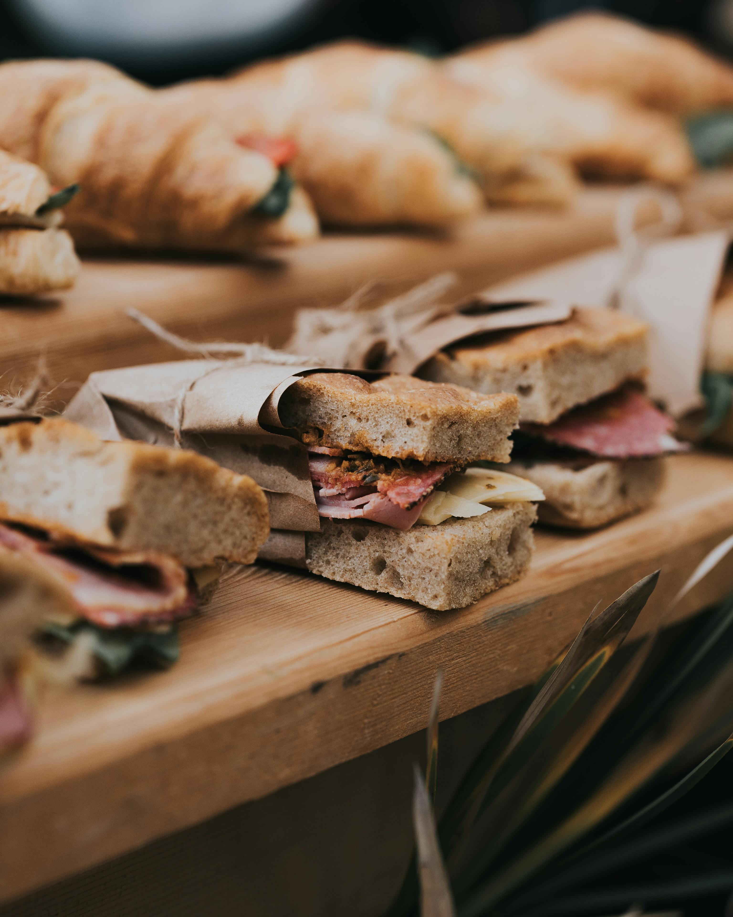 Sandwiches Laid Out on Wooden Table · Free Stock Photo