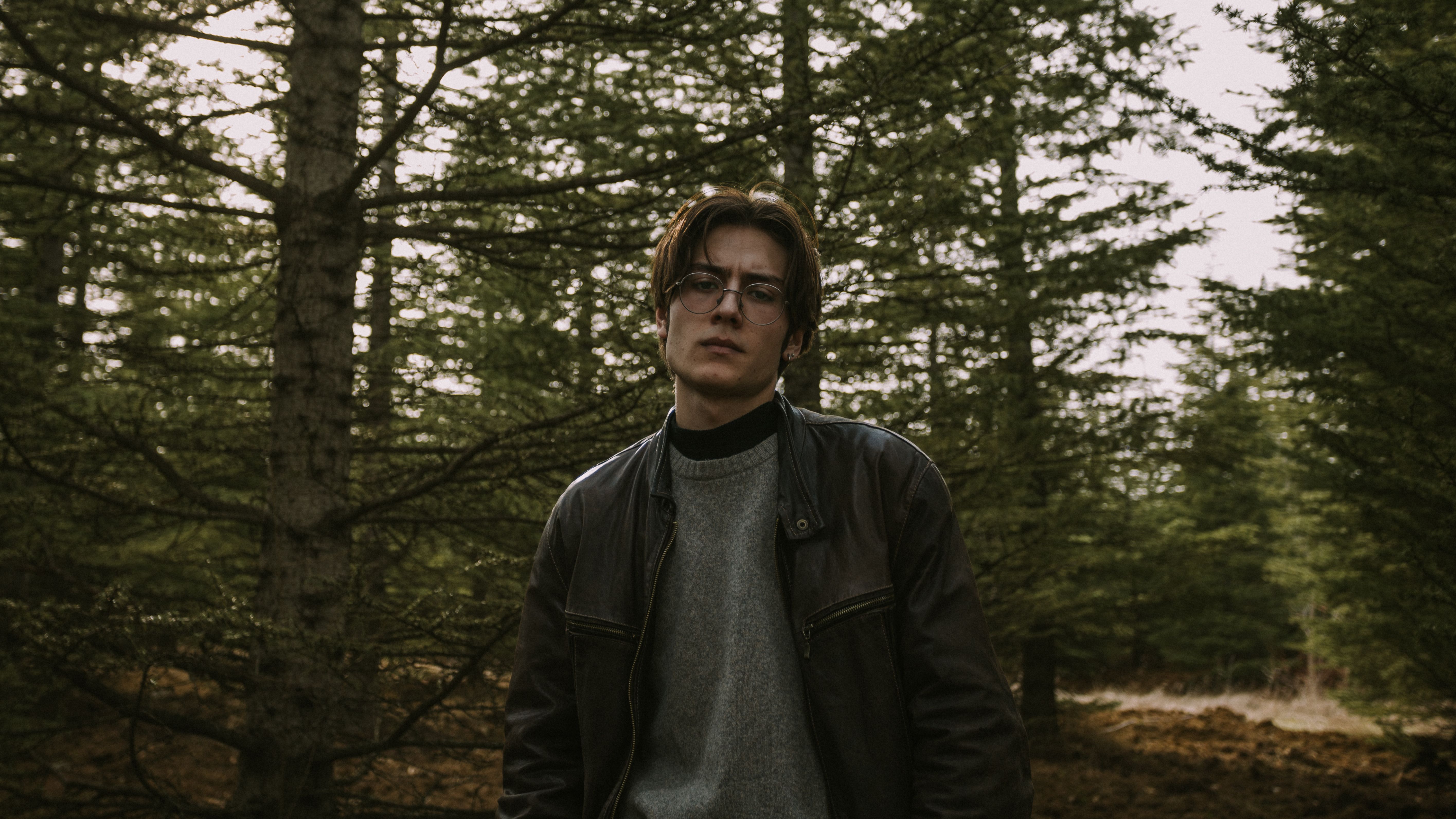 Photography of Man Between Pine Trees · Free Stock Photo