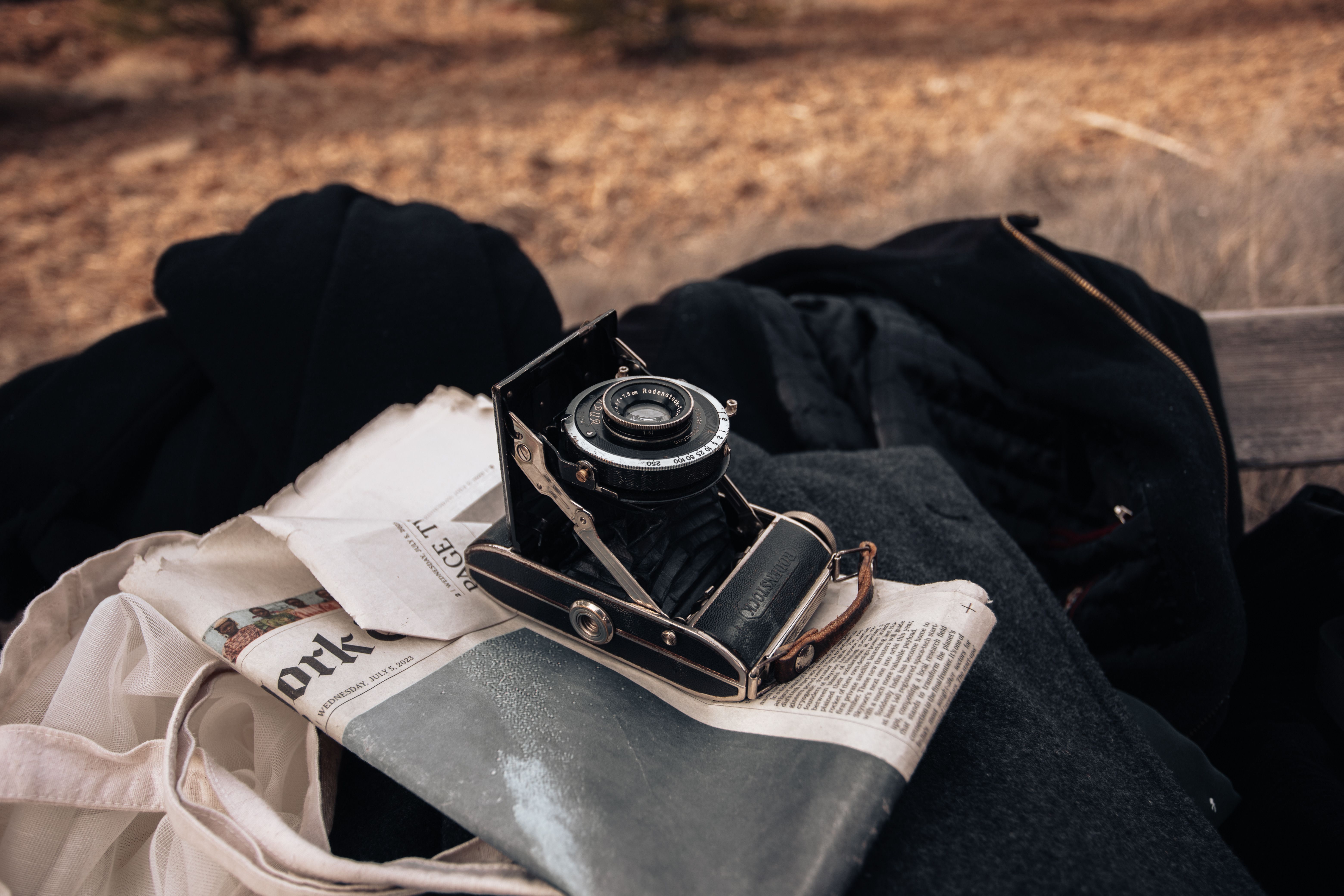 Camera on Newspaper and Clothes · Free Stock Photo