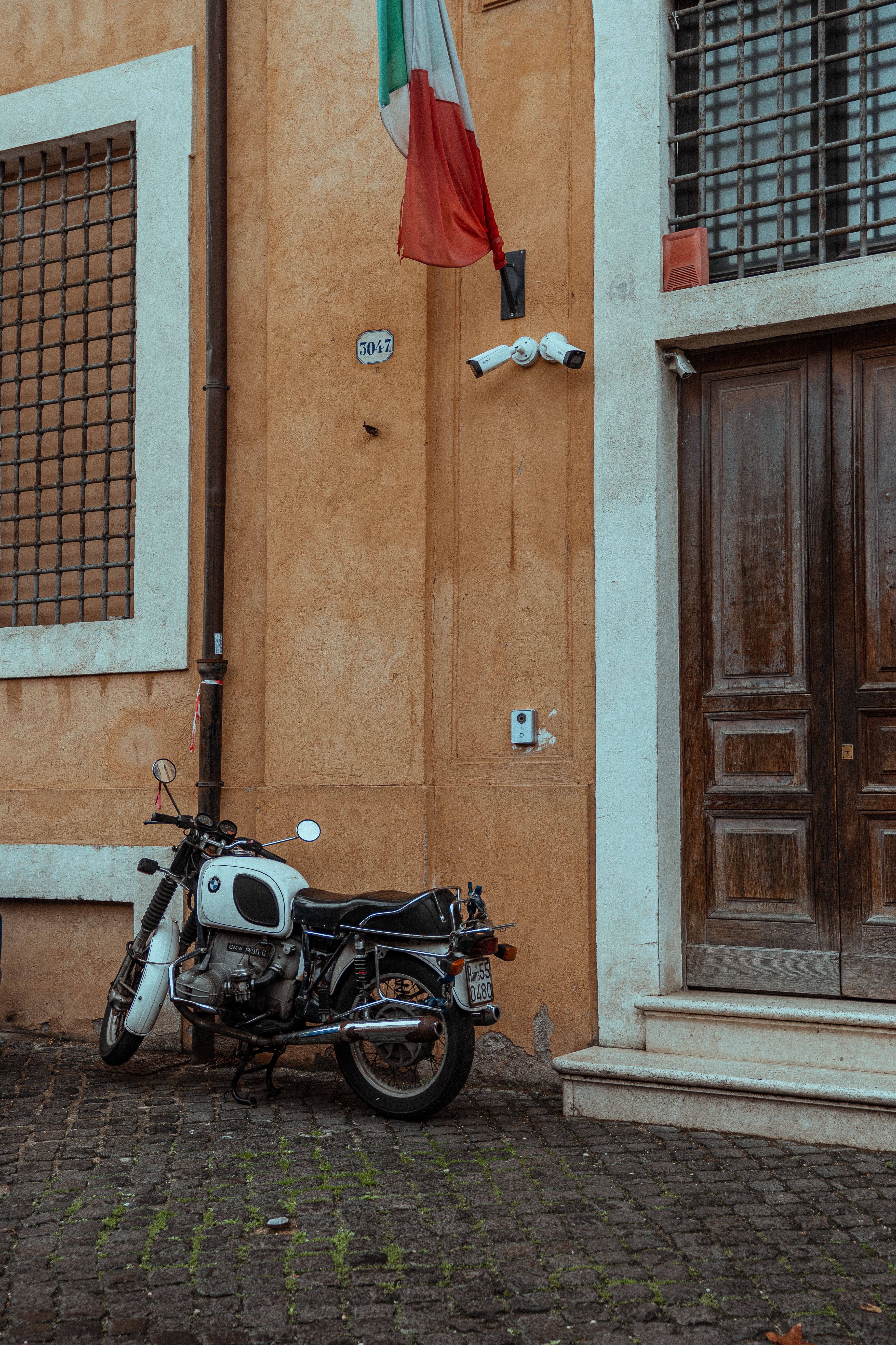 A Motorcycle Parked in Front of a Building · Free Stock Photo