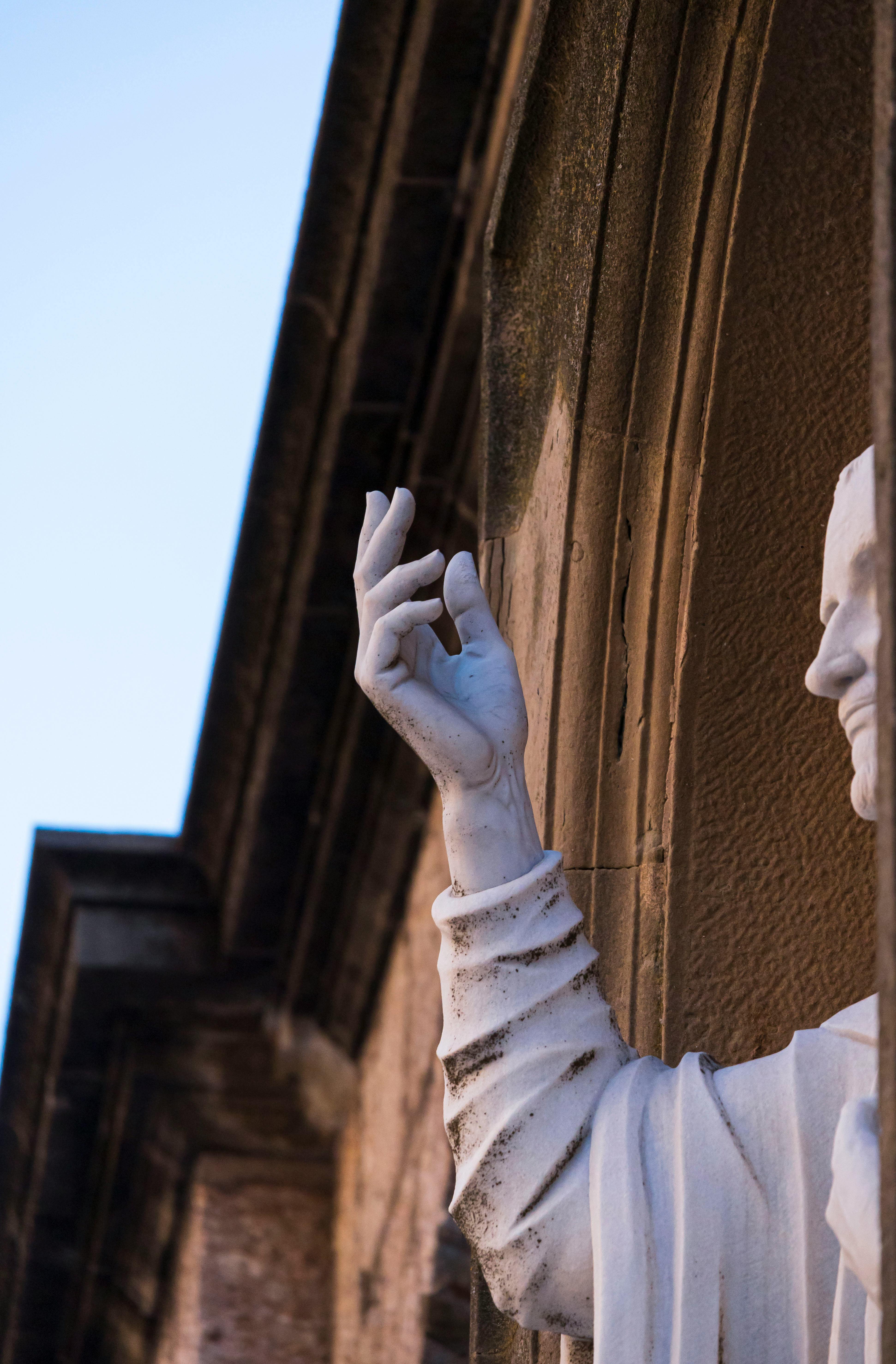 A statue of jesus holding up his hand · Free Stock Photo