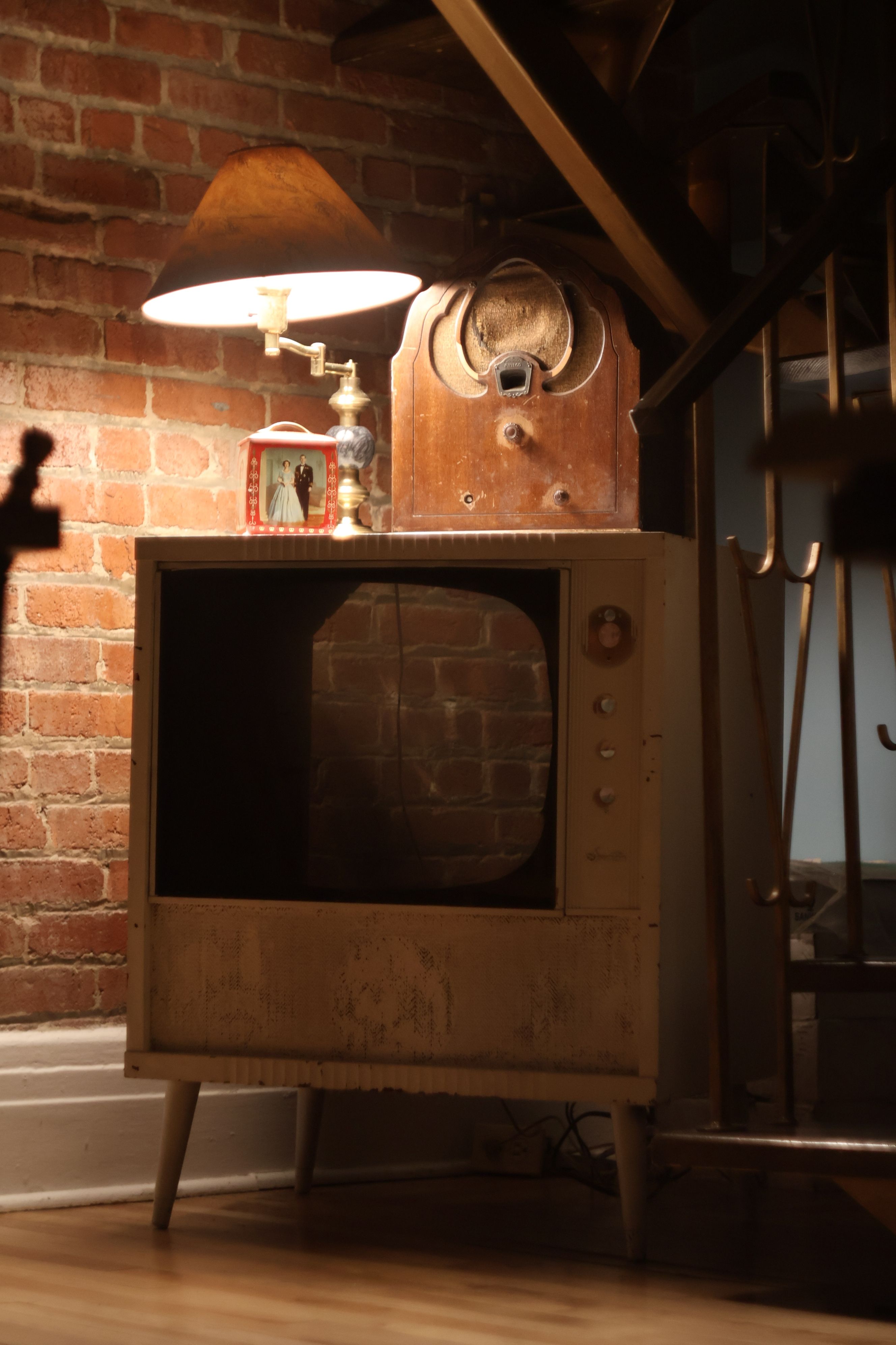 An old television sitting on a table next to a lamp · Free Stock Photo