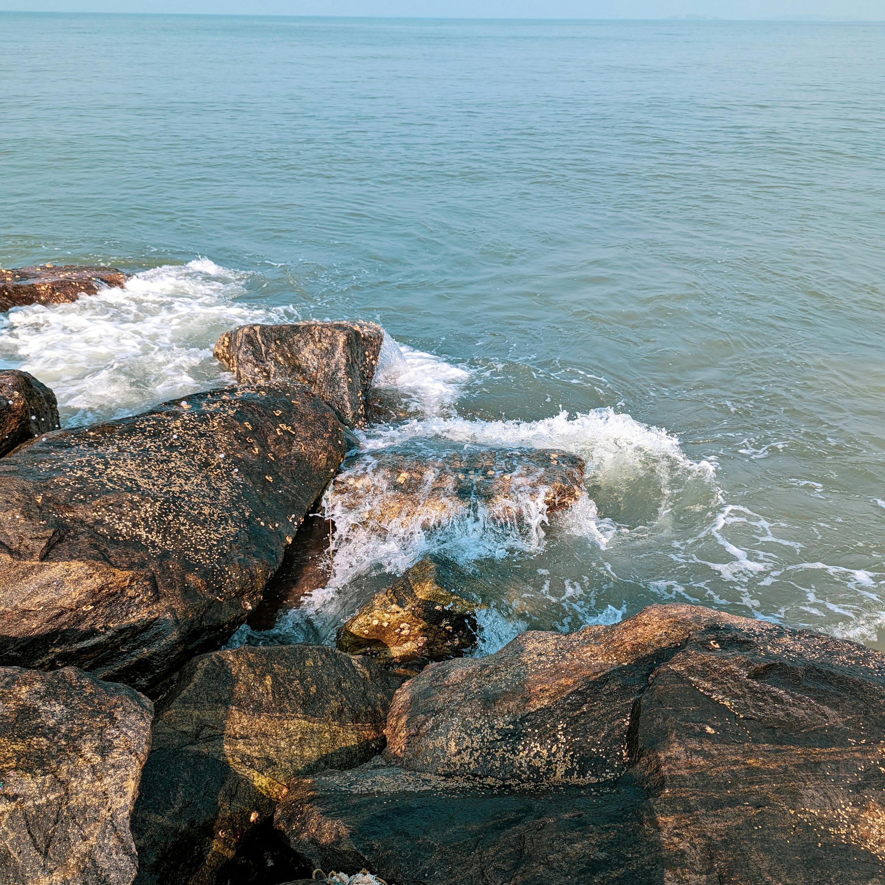 Brown Rock Formation on Body of Water at Daytime · Free Stock Photo