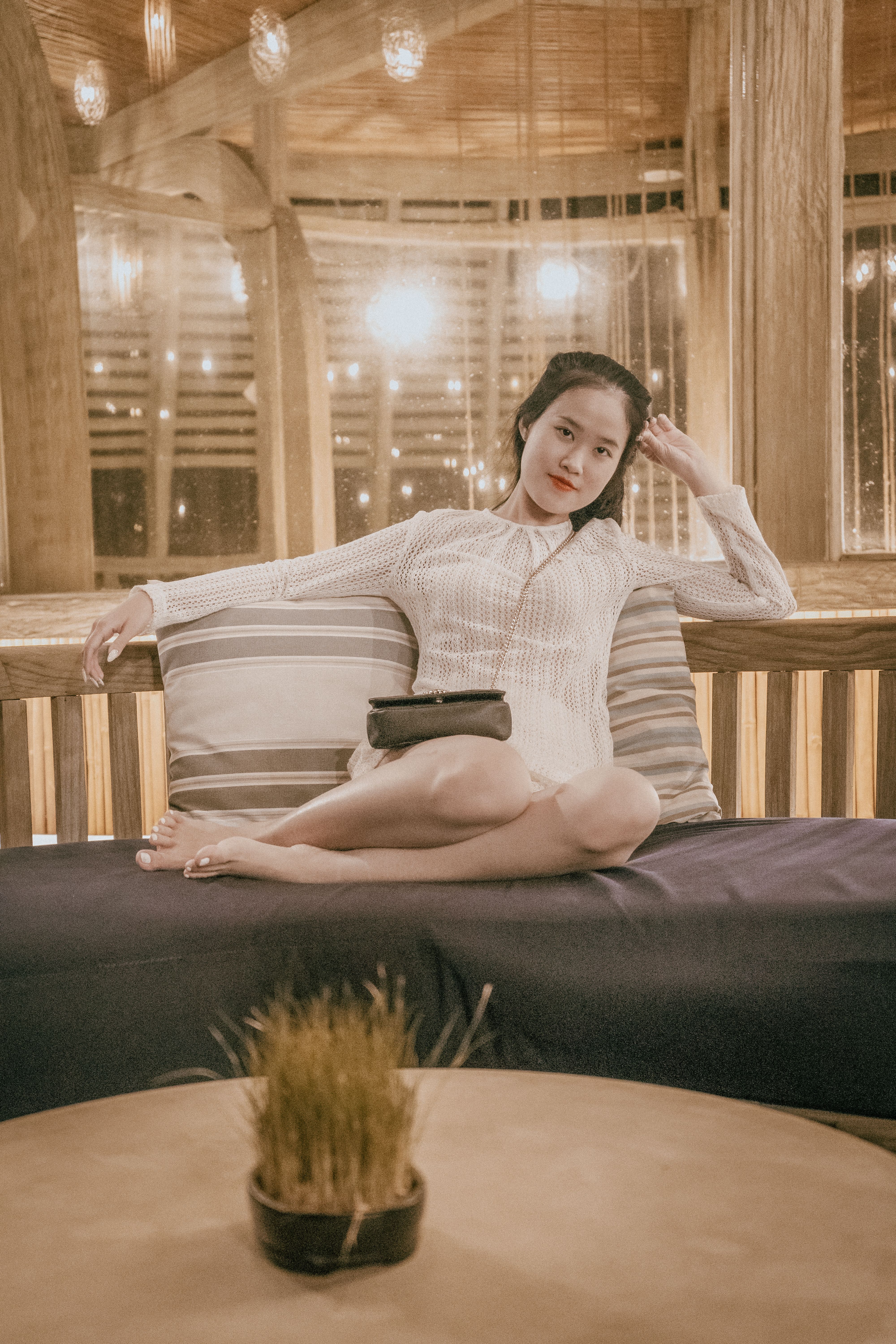 Female Model Sitting Barefoot on a Sofa · Free Stock Photo