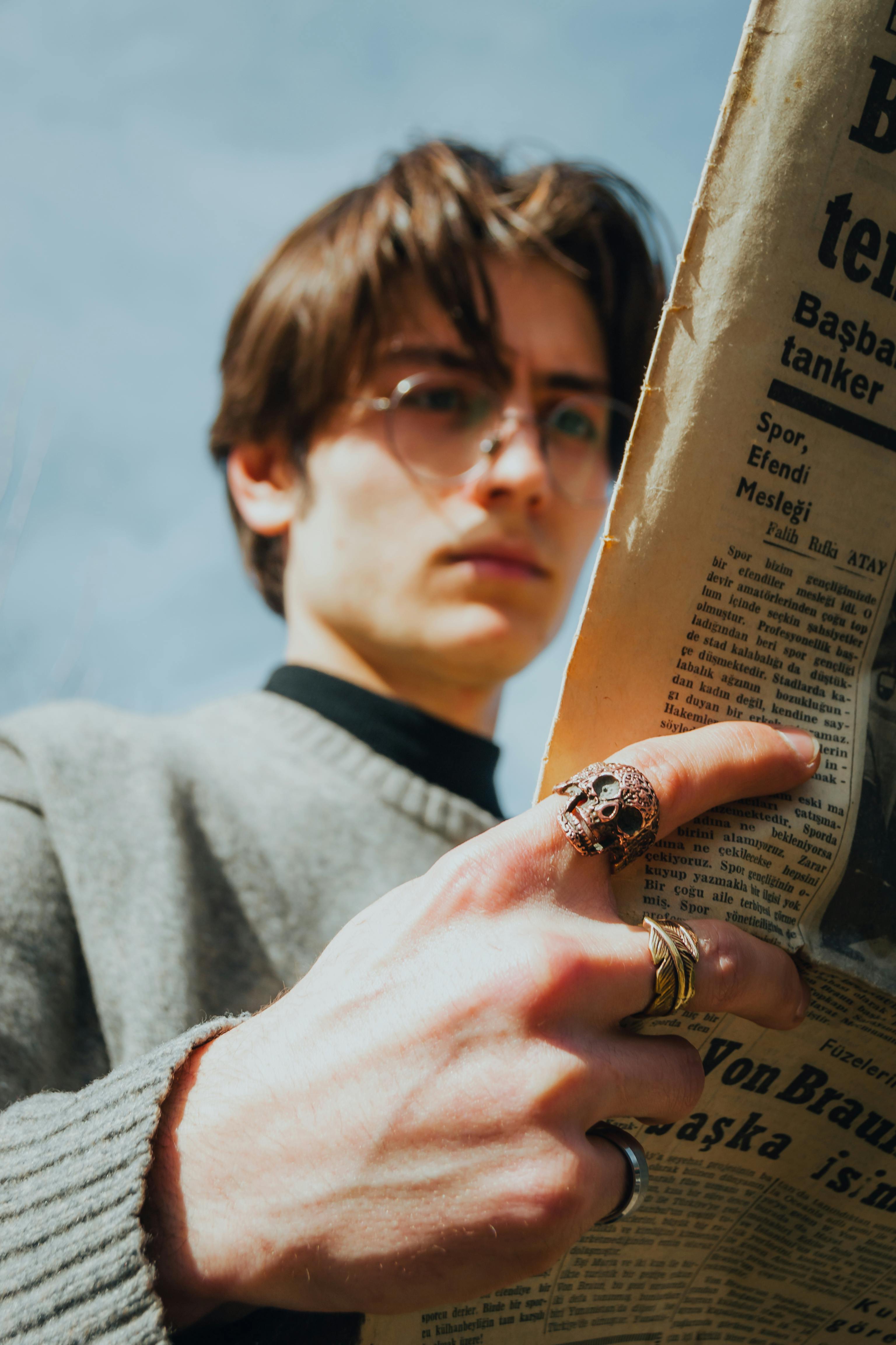 Person in Jacket Holding Magazine in Hand · Free Stock Photo