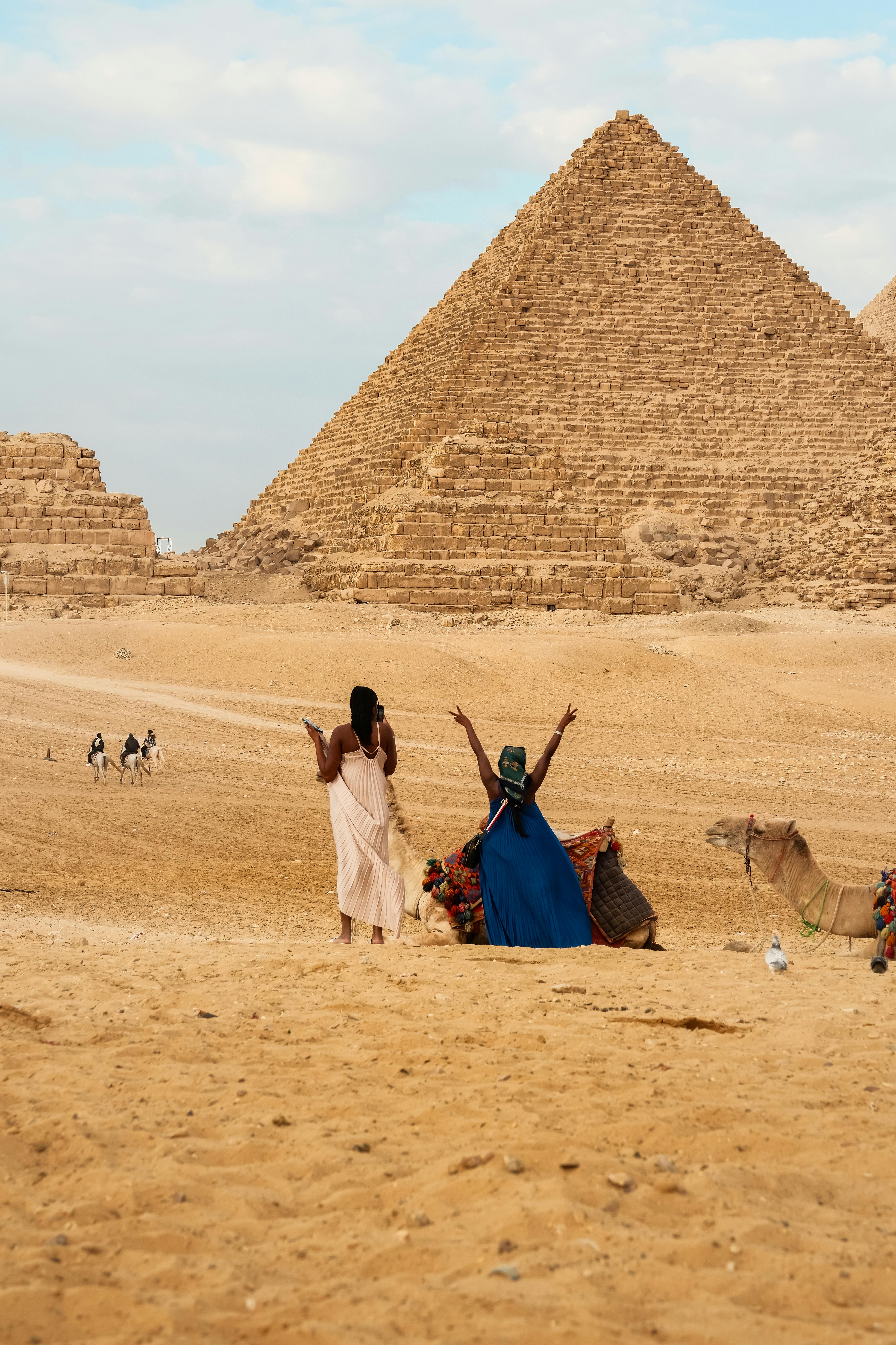 People Posing in front of a Pyramid · Free Stock Photo