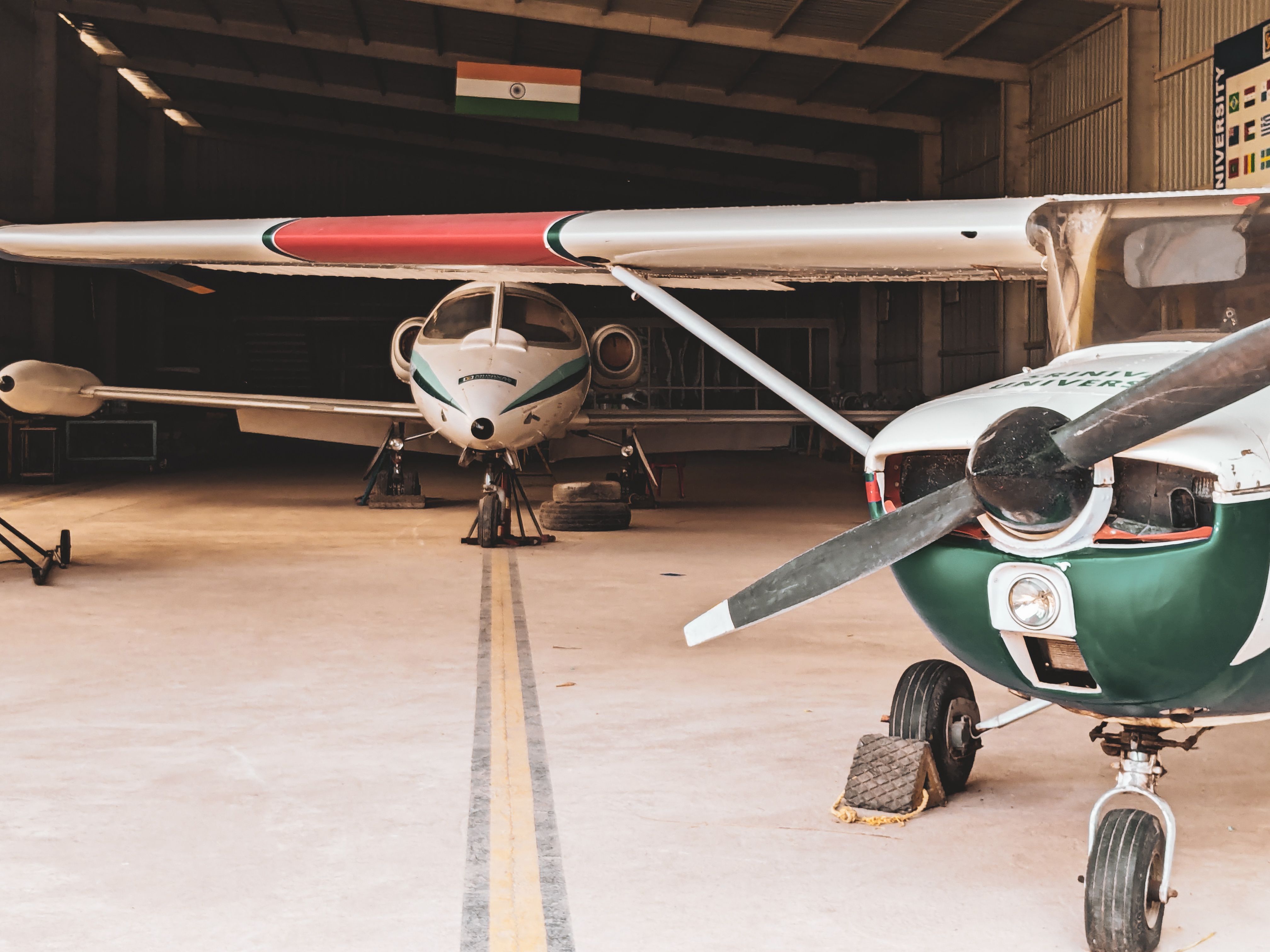 A small airplane parked in a hangar with a propeller · Free Stock Photo