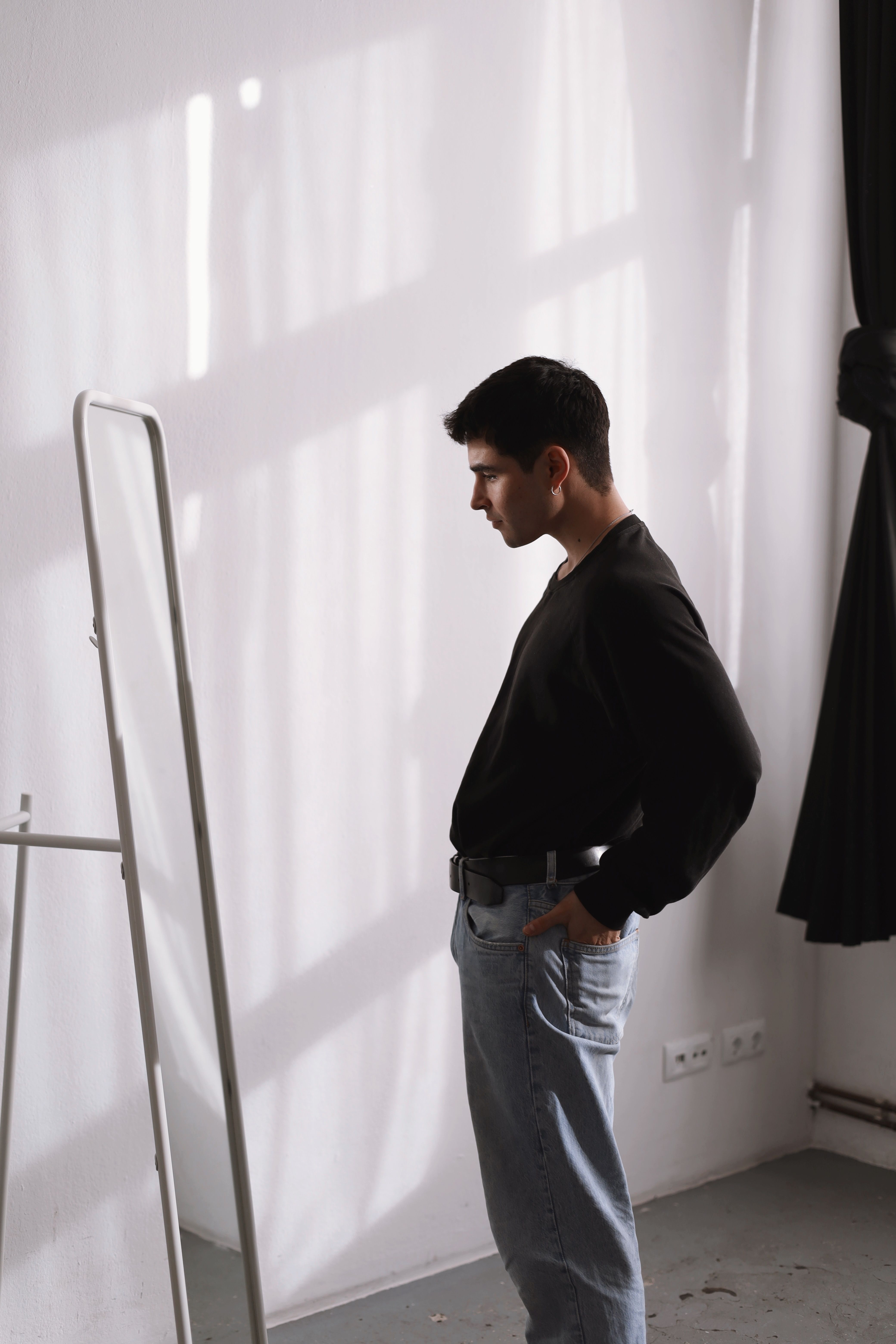 Side View of a Man Standing in Front of a Mirror · Free Stock Photo