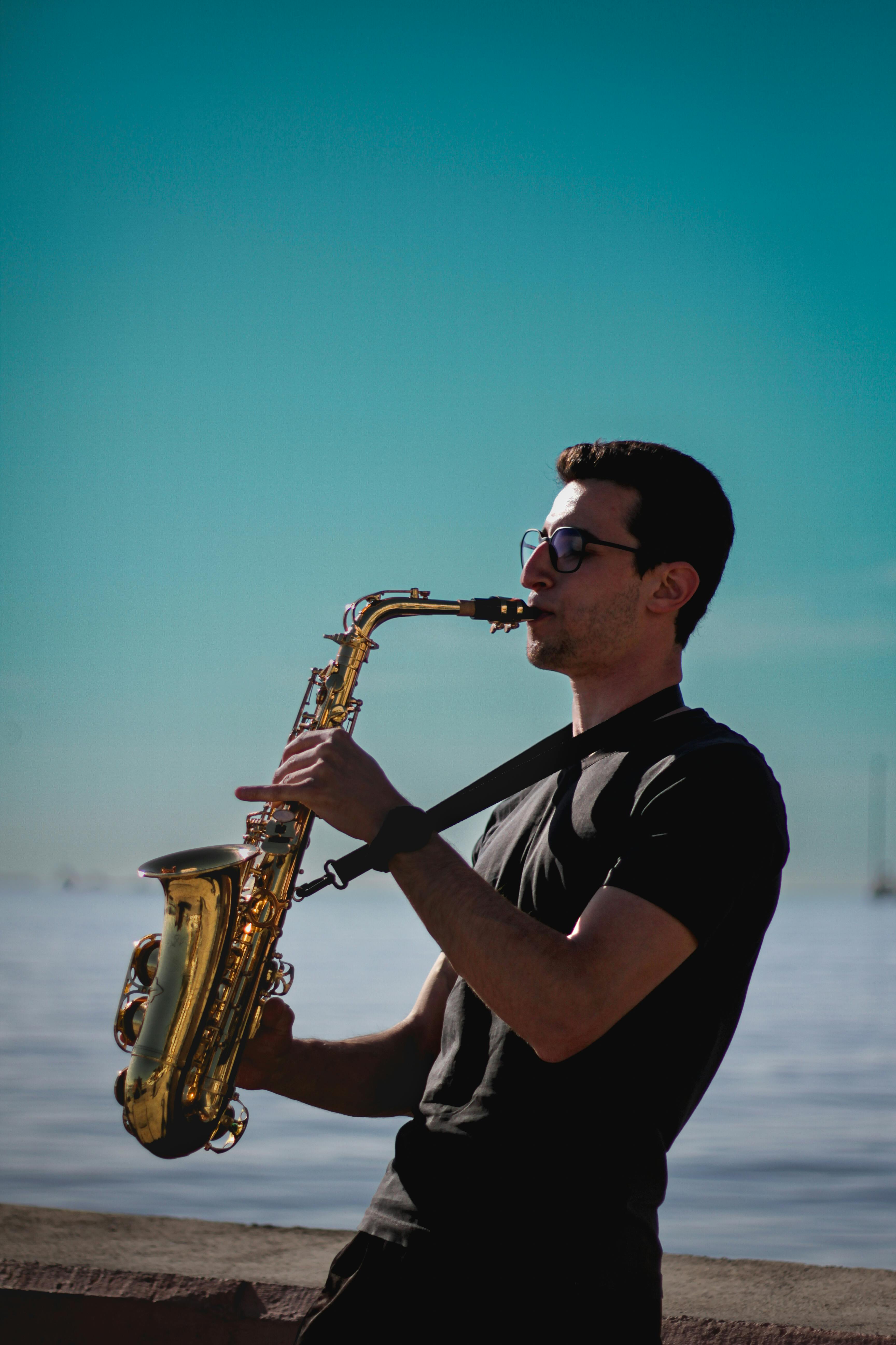 Portrait of Man Playing Saxophone on Sea Shore · Free Stock Photo