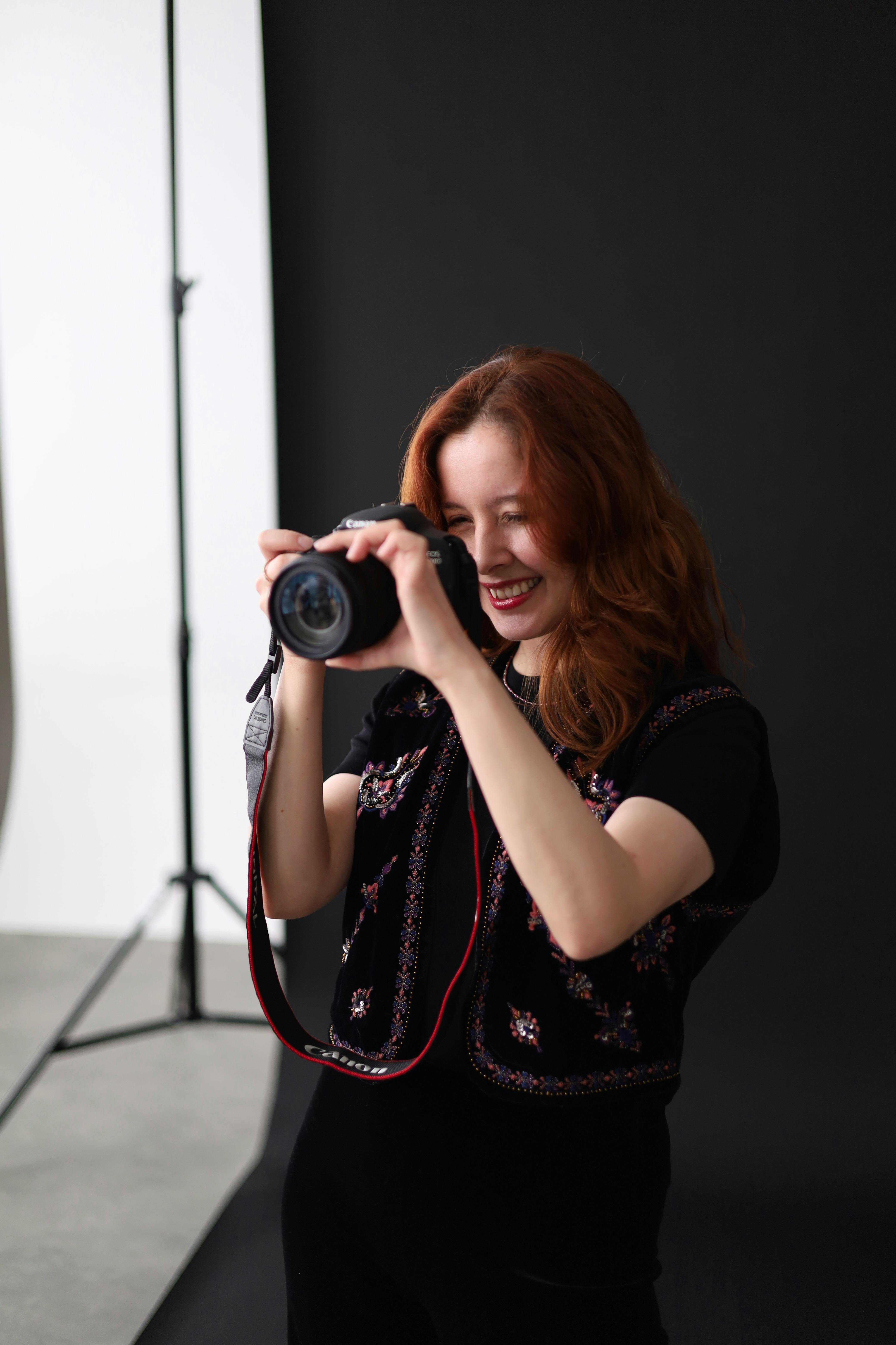 A Photographer Taking Pictures in a Studio · Free Stock Photo