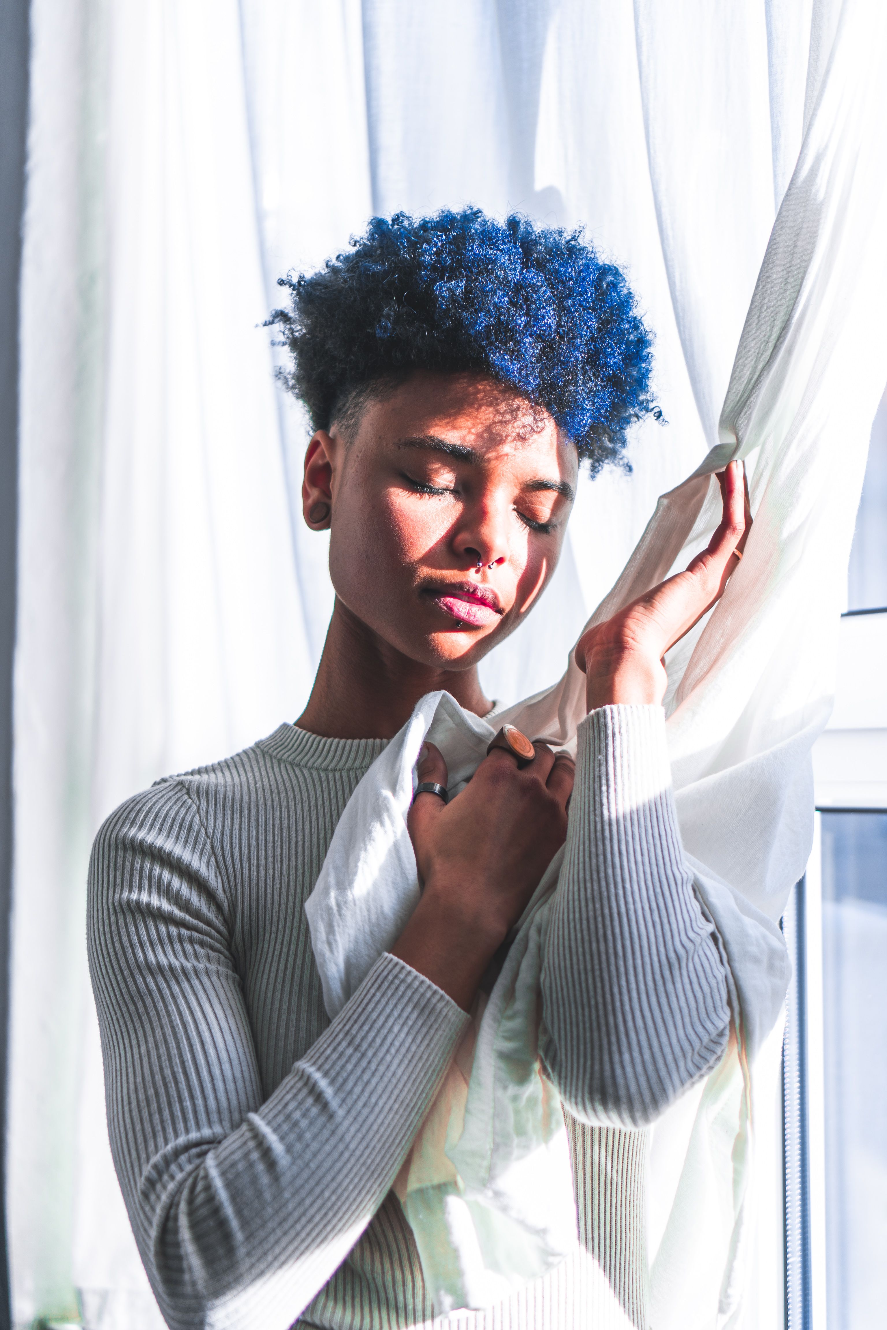 Young Woman Caressing a Curtain · Free Stock Photo