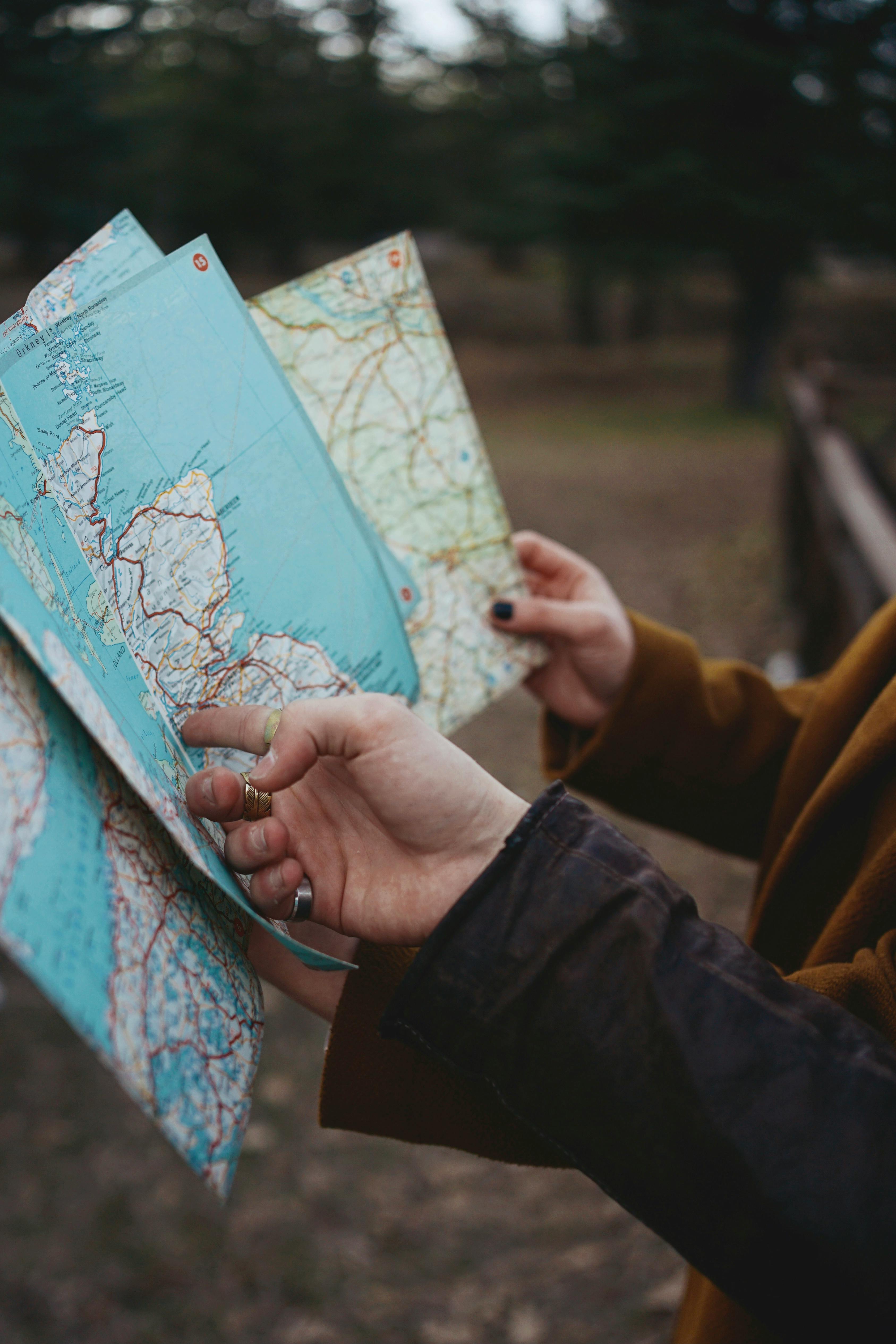 Woman Holding a Map in a Forest · Free Stock Photo
