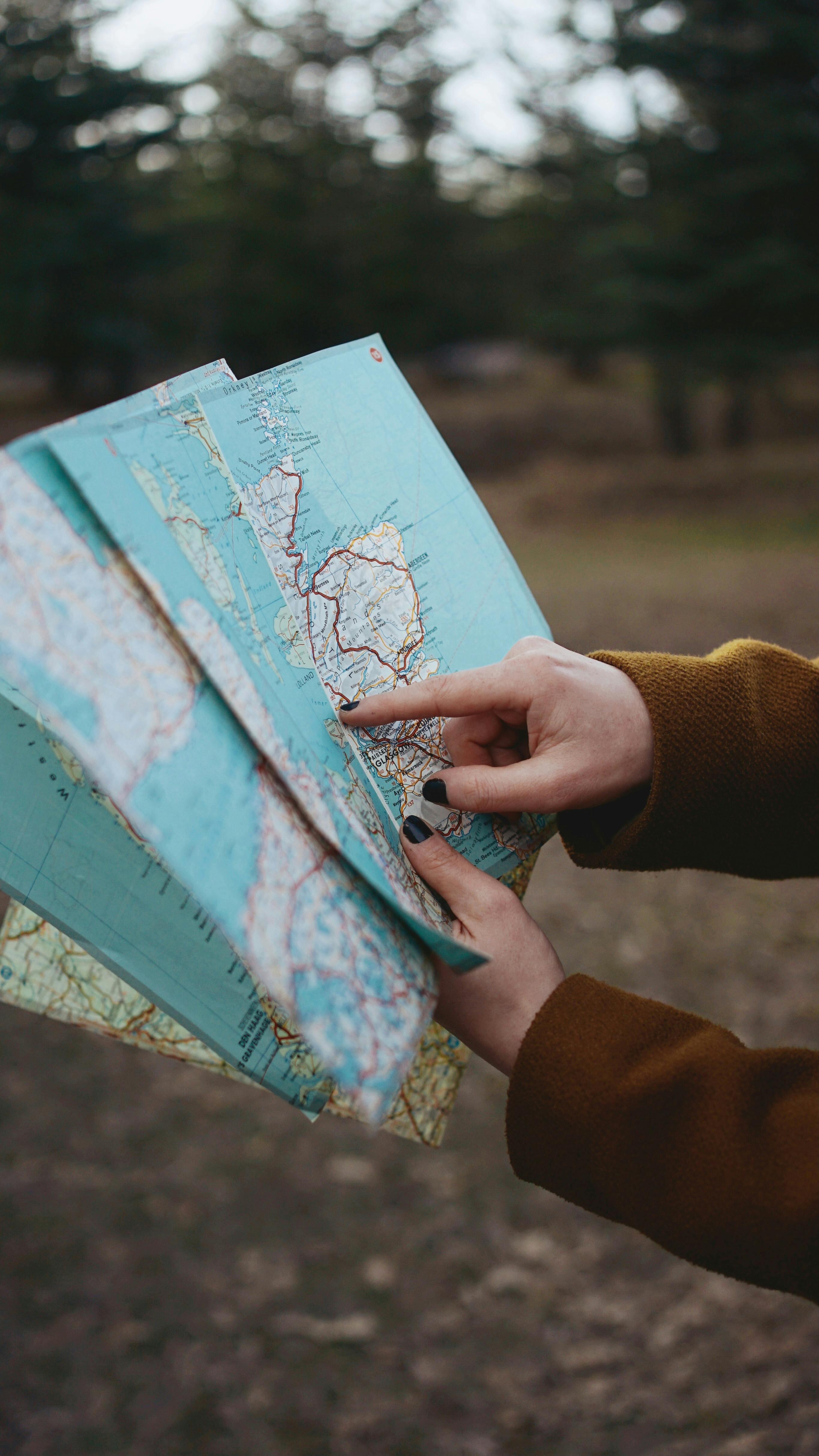 Person Holding Map Inside Vehicle · Free Stock Photo