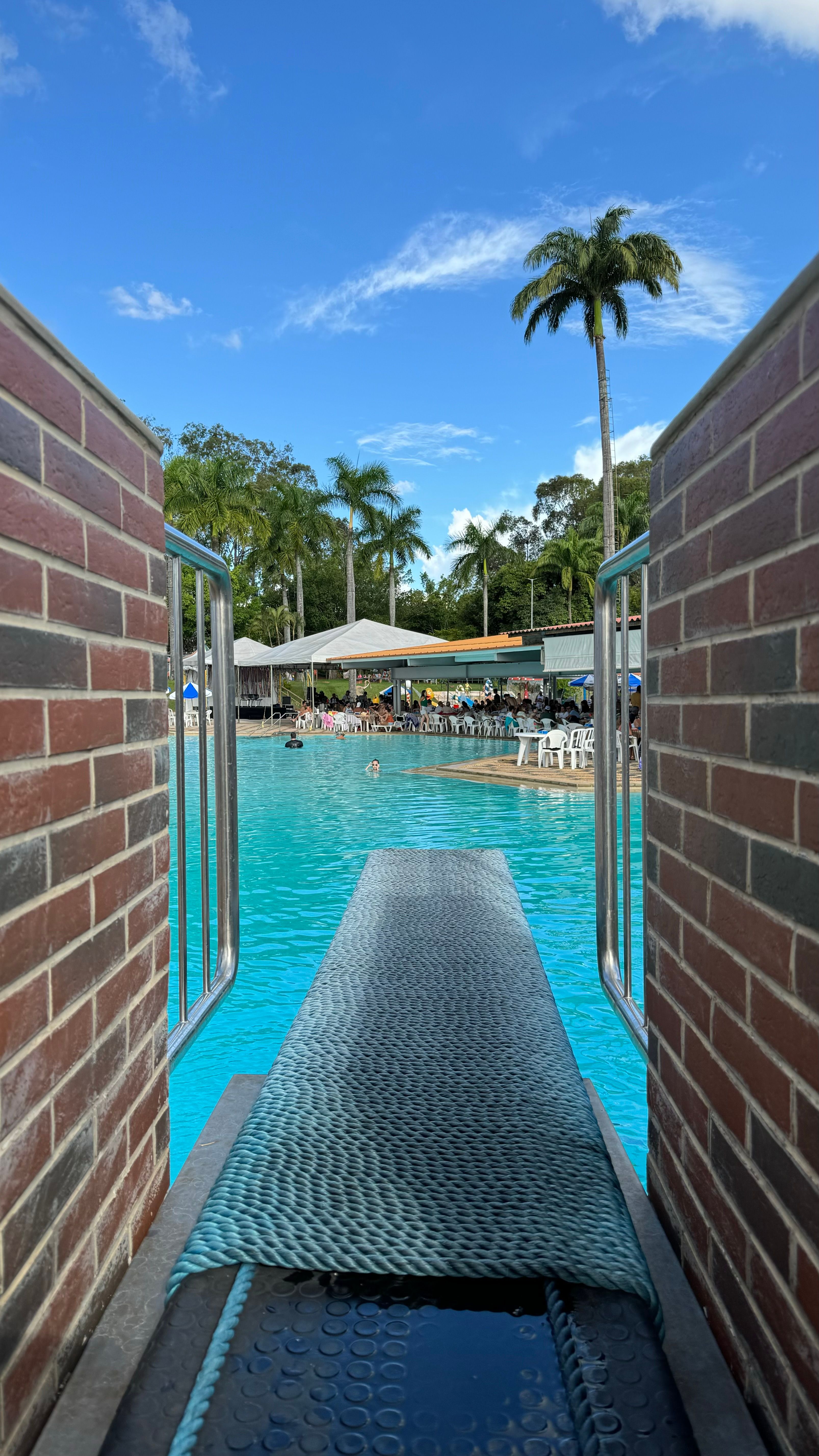 A pool with a slide and a brick wall · Free Stock Photo