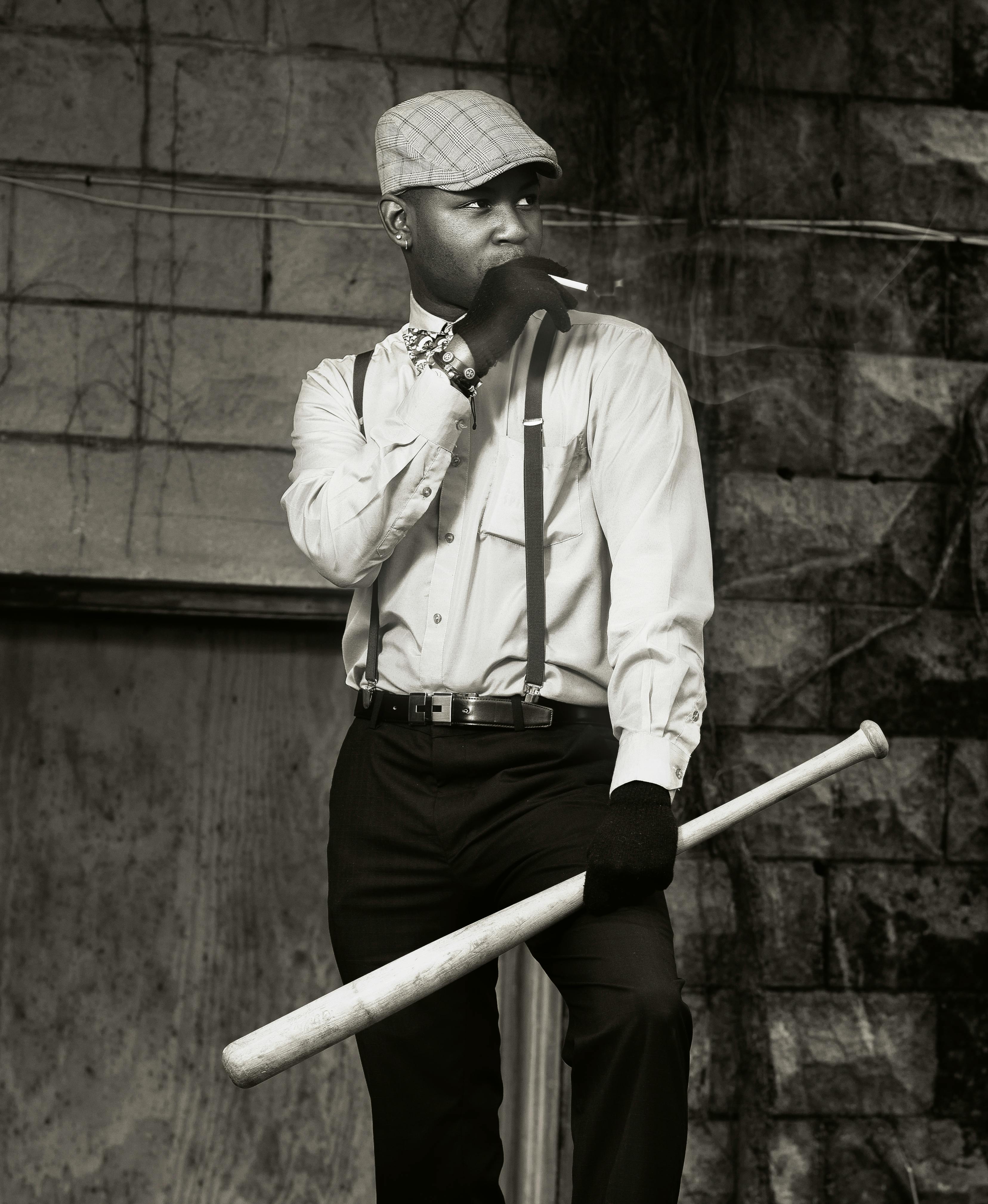 Man in Shirt and Ivy Cap Smoking Cigarette and Holding Baseball Bat ...