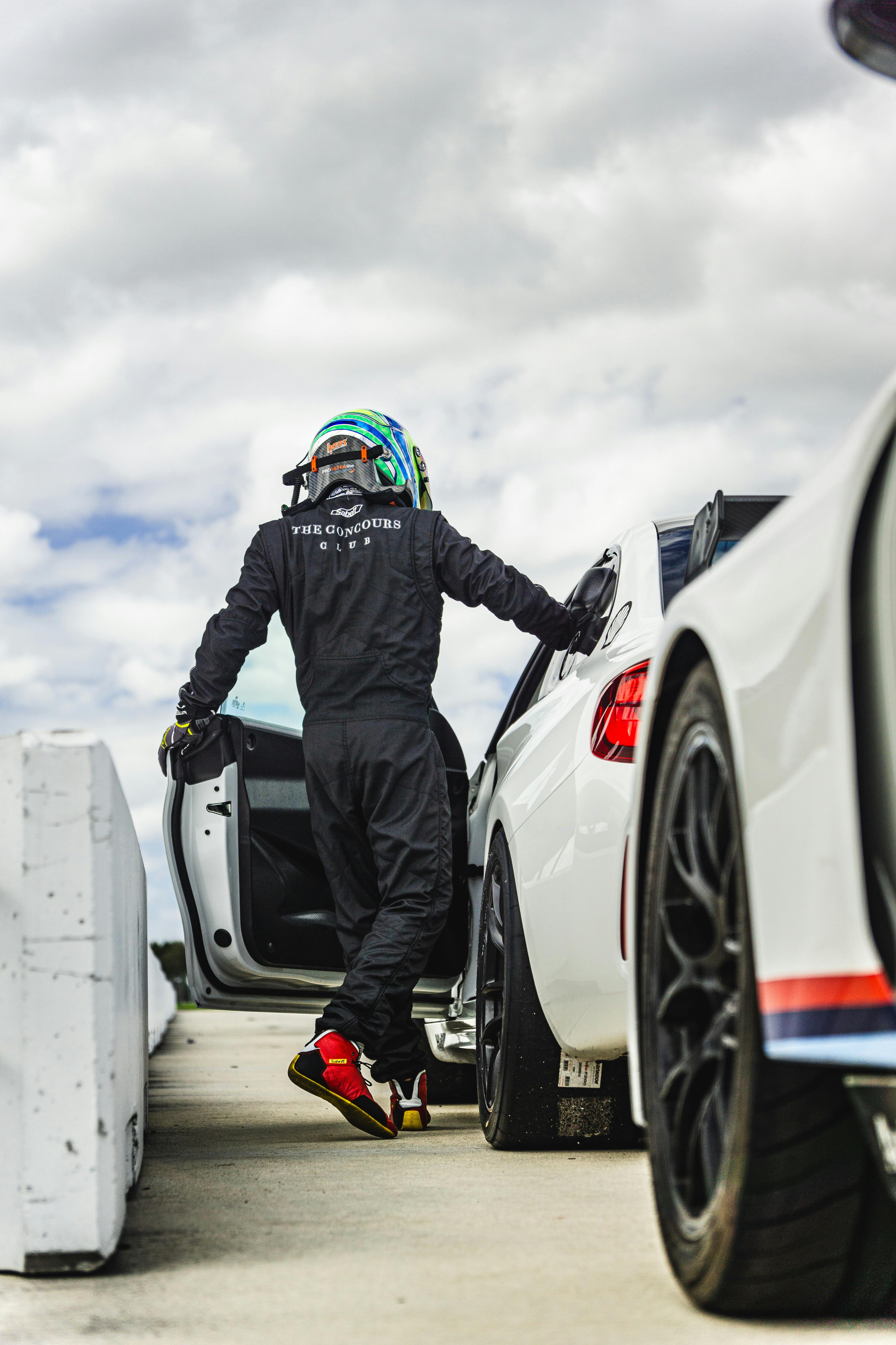Man in Blue and and White Racer Suit Wearing His Blue and Yellow Star ...