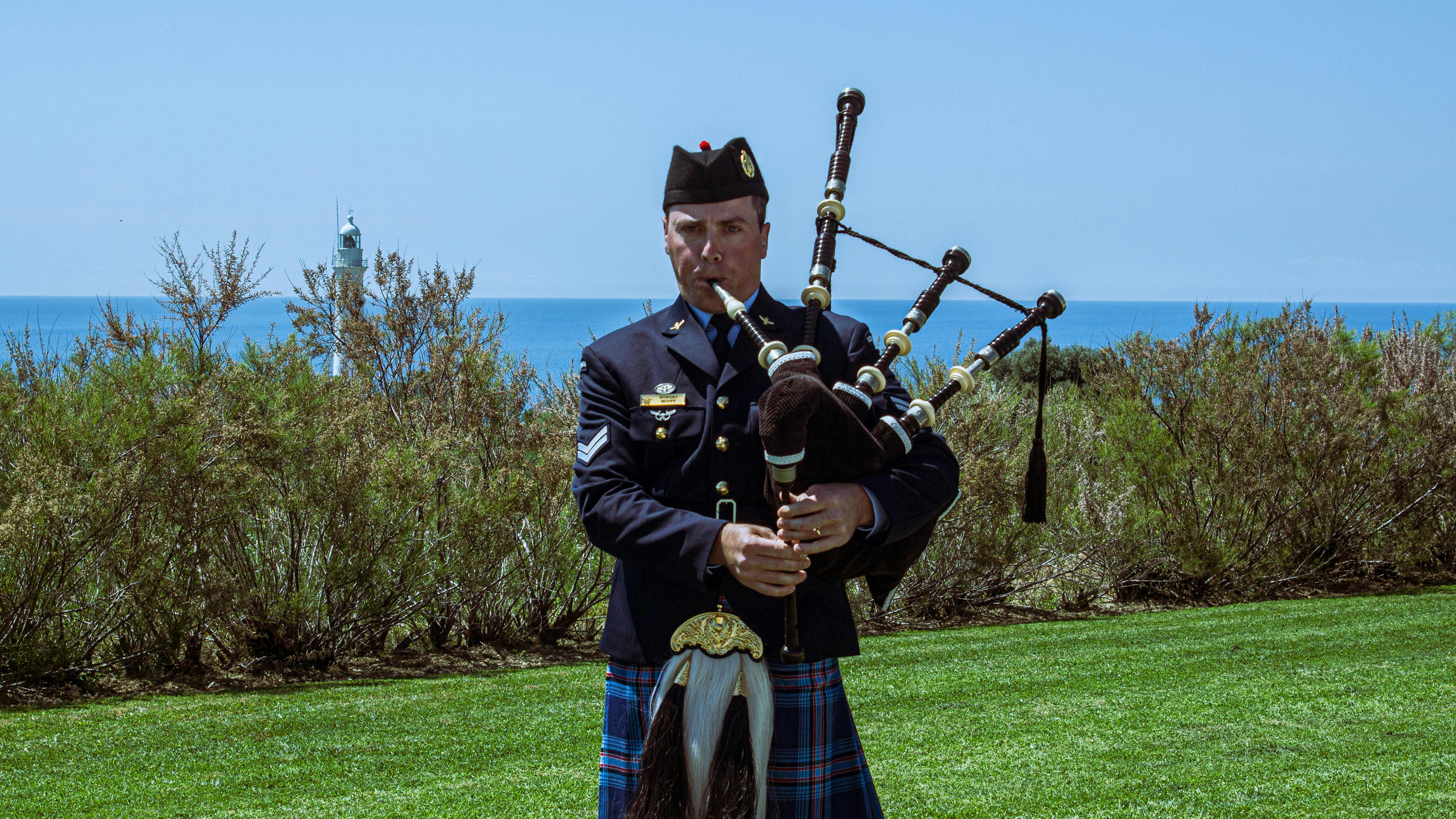 A Man in a Uniform Playing Bagpipes · Free Stock Photo