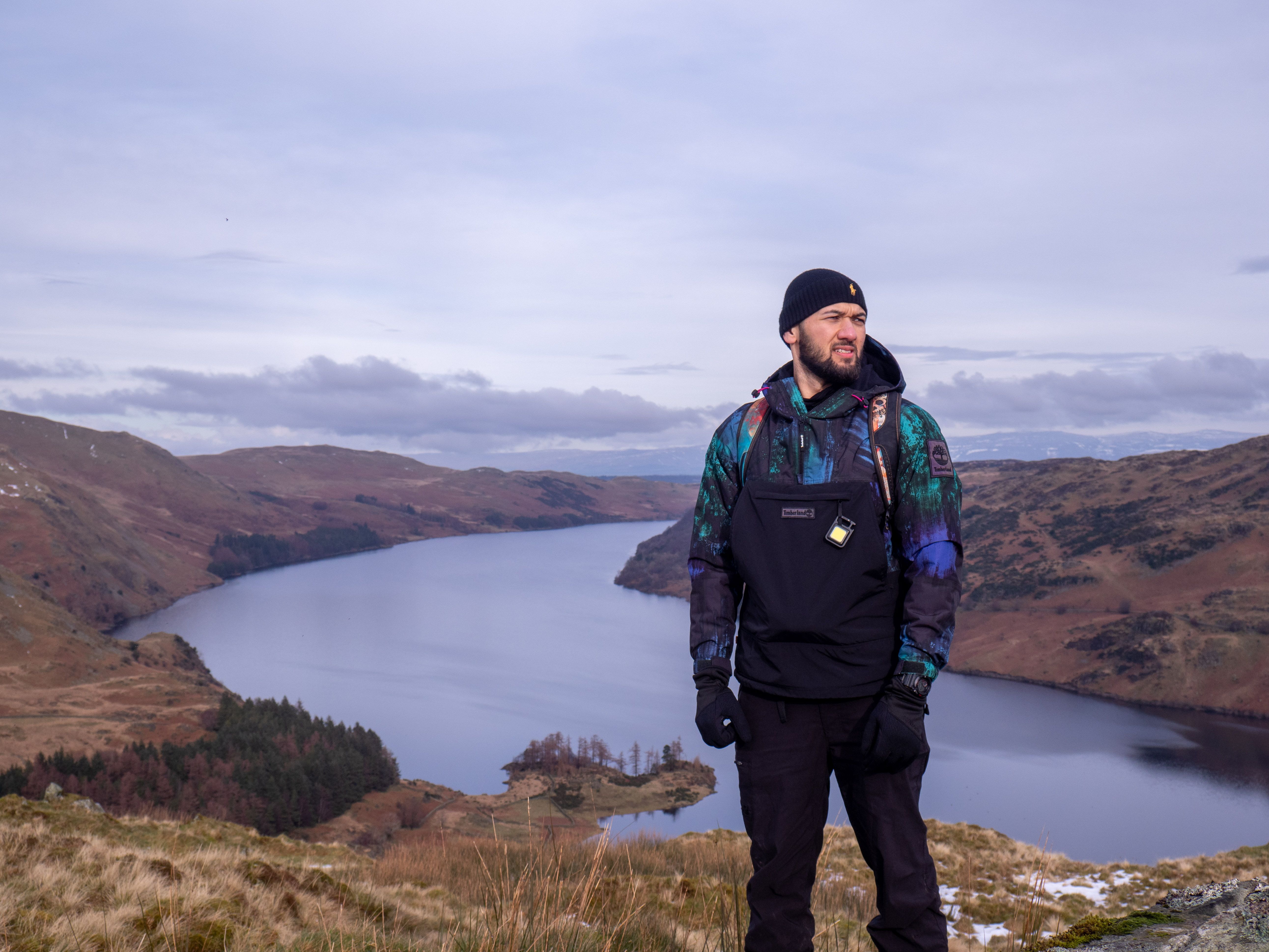 Happy Hiker Stands against River · Free Stock Photo