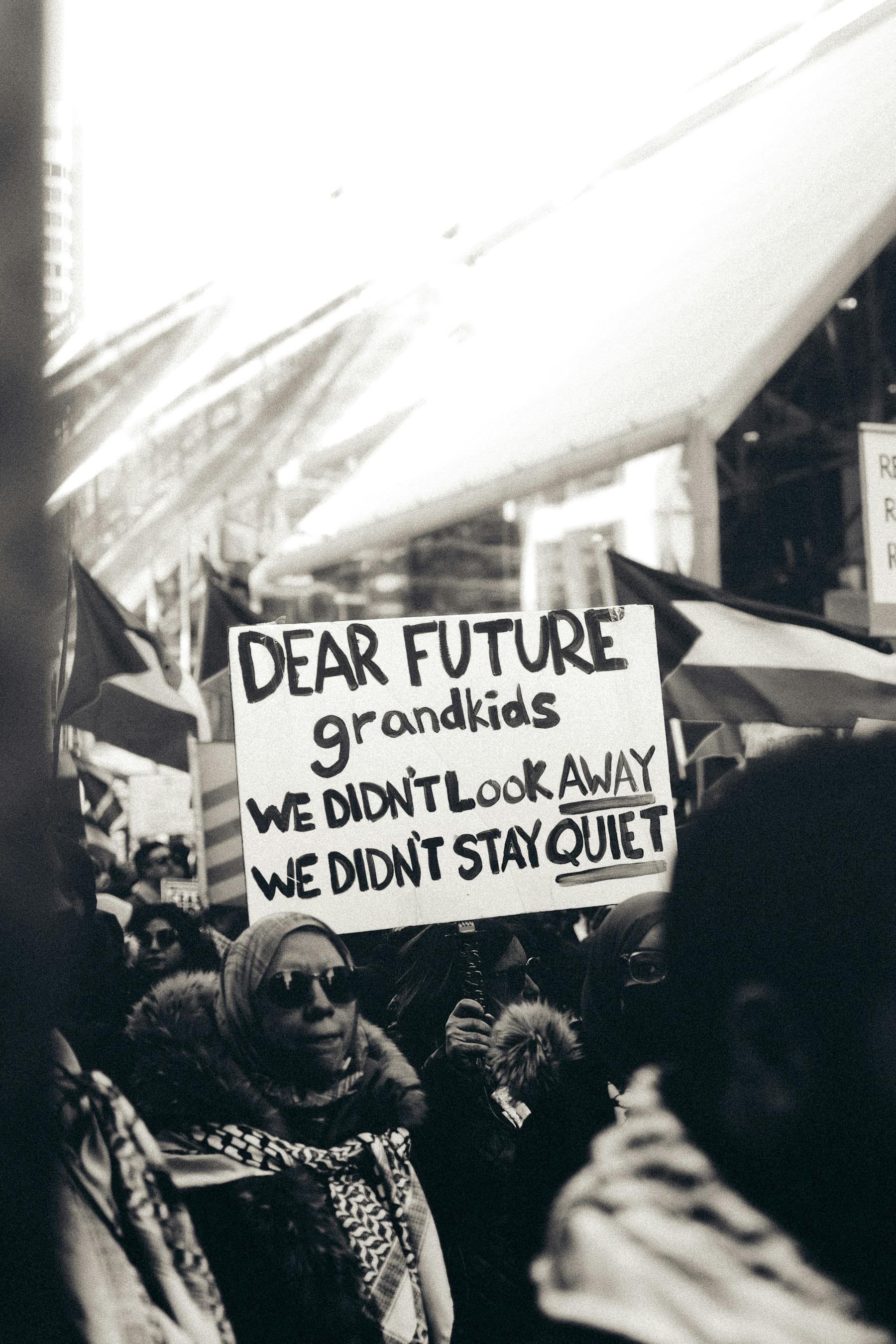 A protest sign with the words dear future grandchildren · Free Stock Photo