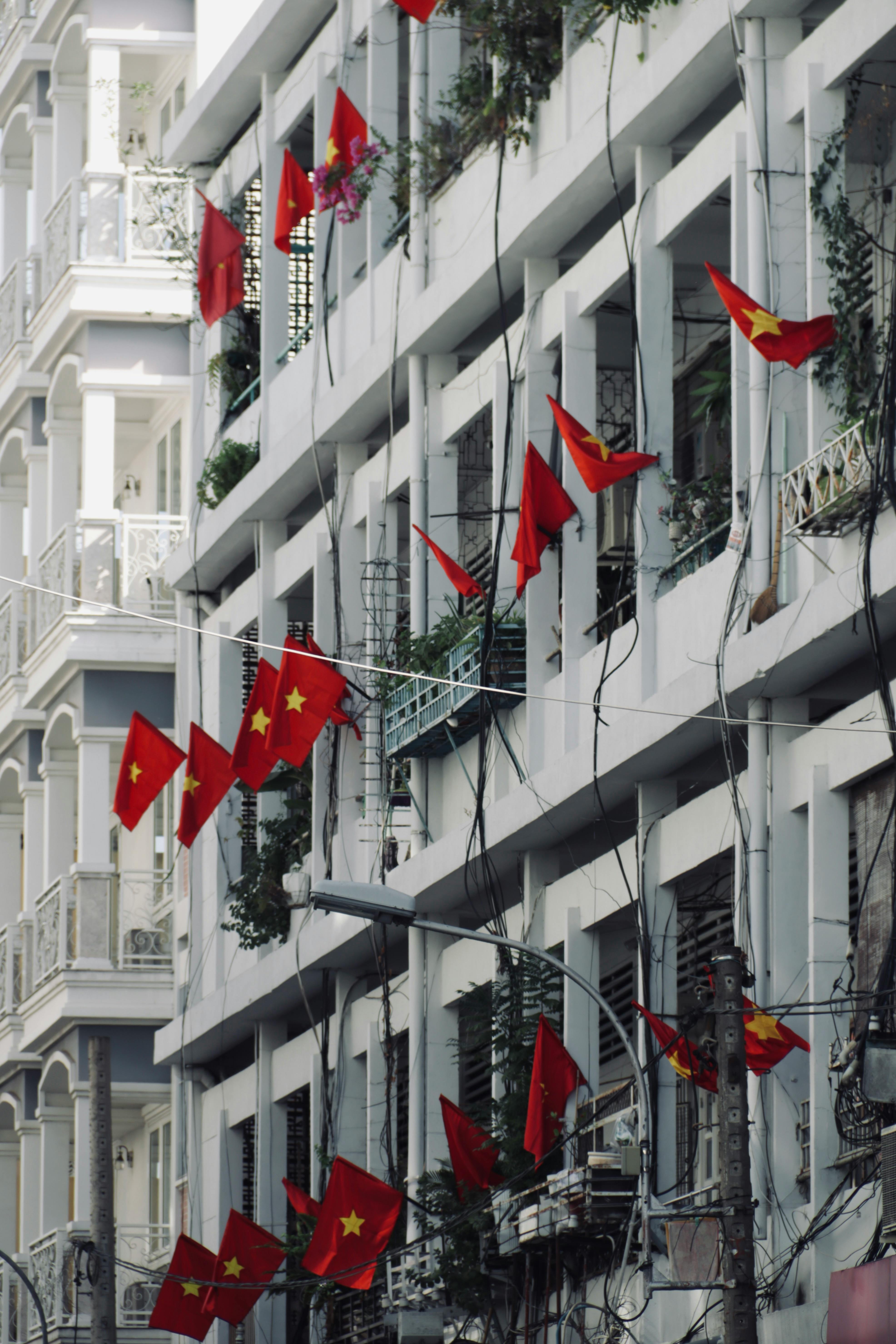 Flags of Vietnam Hanging on Building Wall · Free Stock Photo
