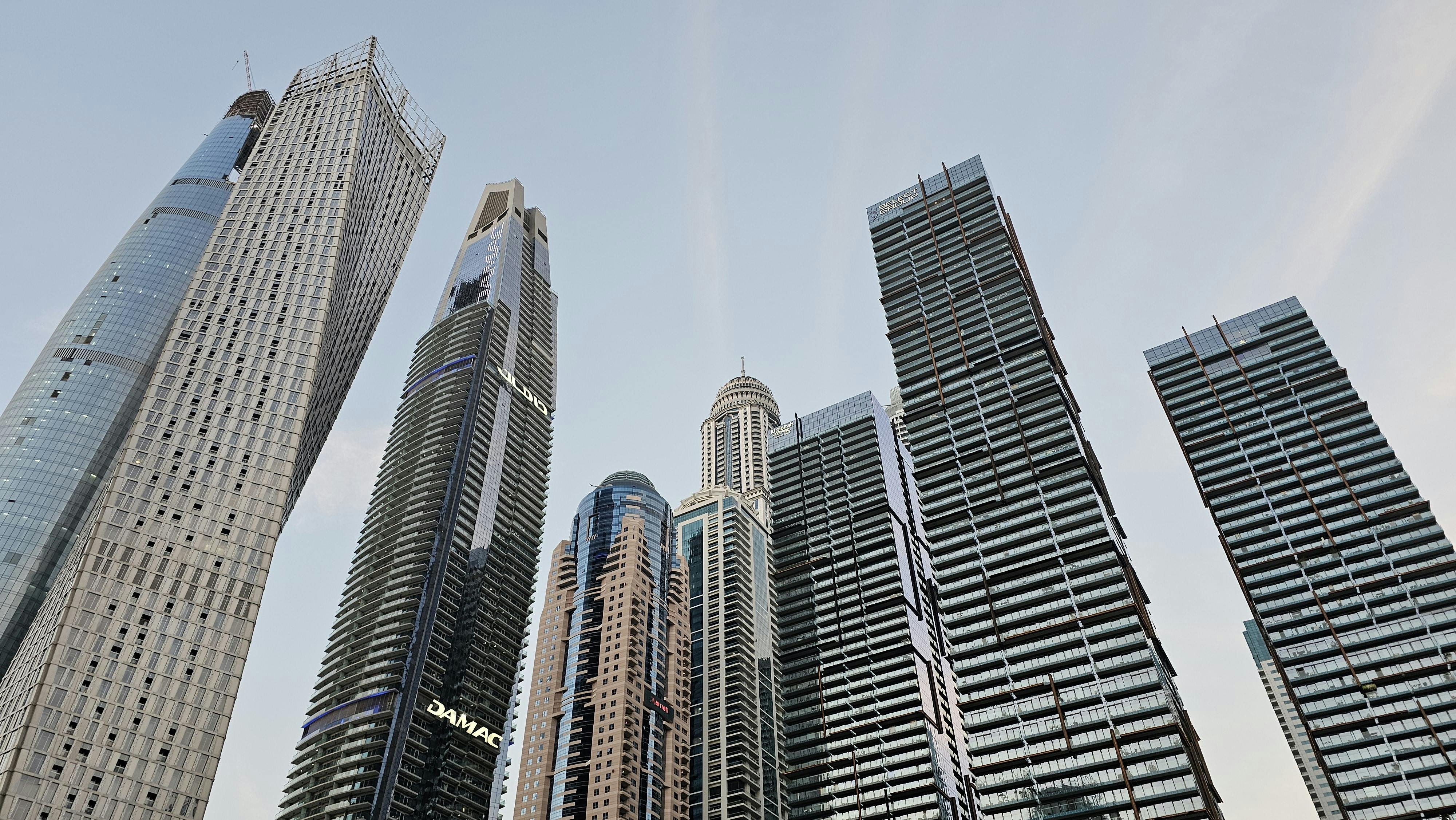 Man Standing in Assorted Building String Light during Night Time · Free ...