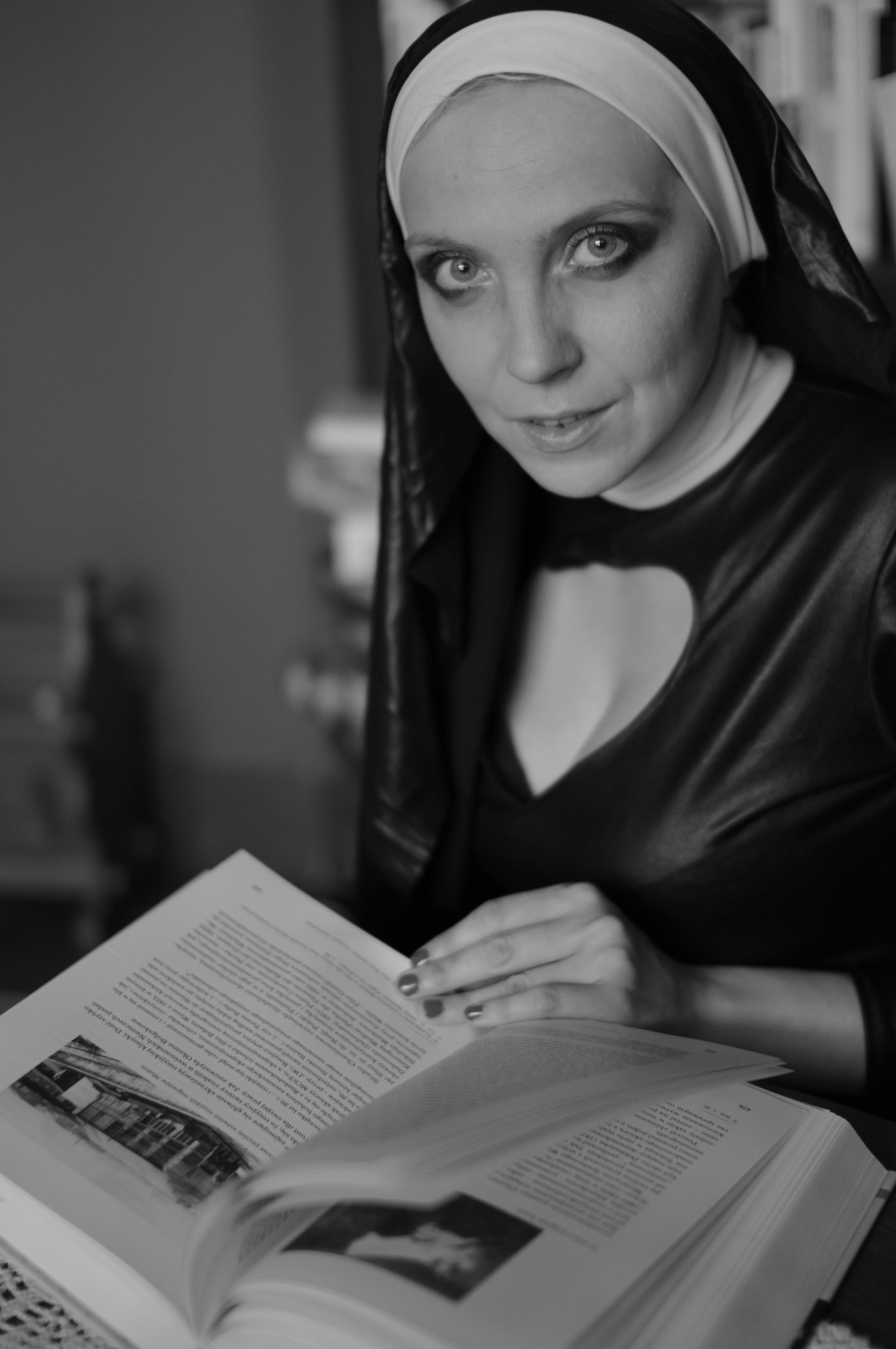 A woman in nun costume reading a book · Free Stock Photo