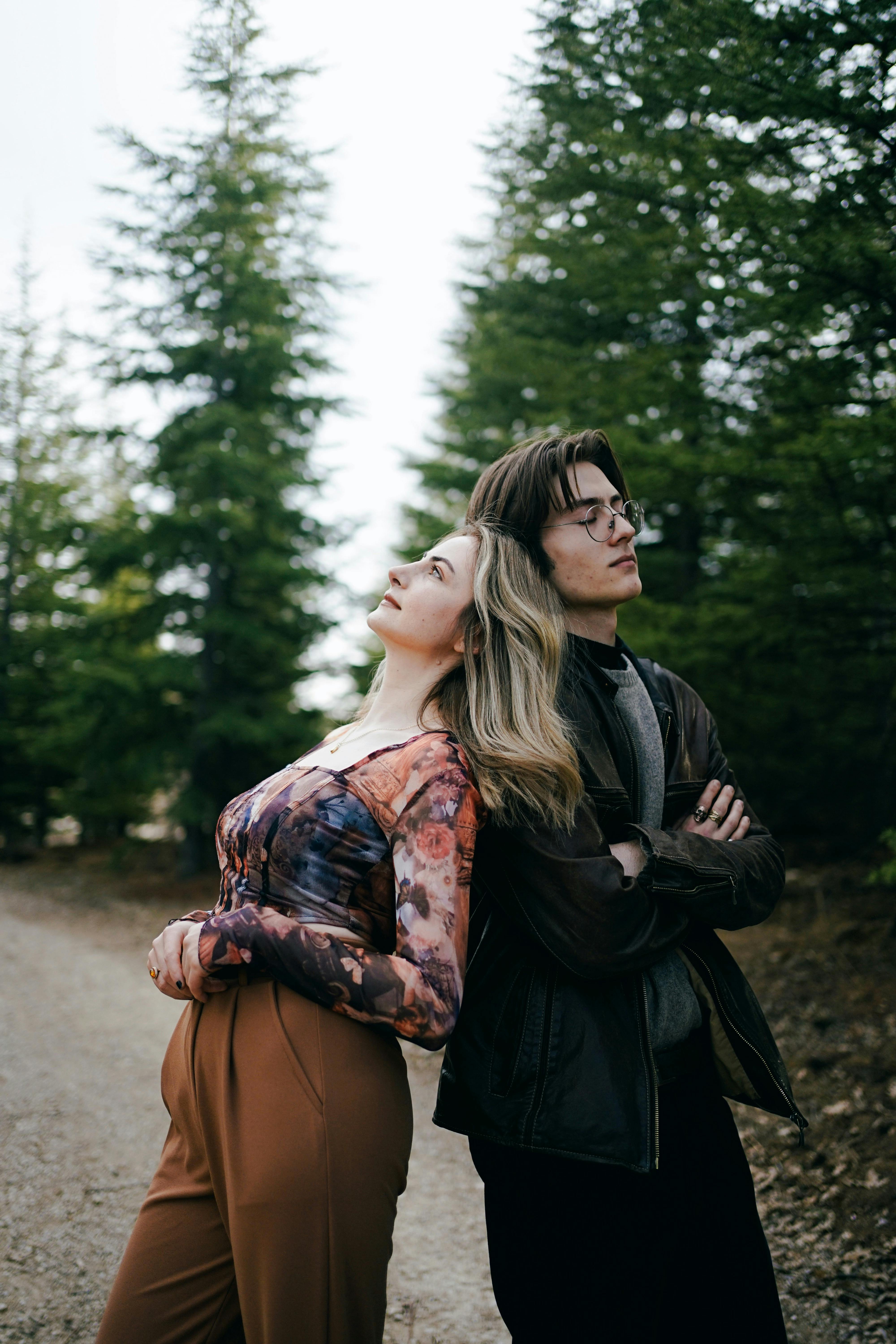 Man and Woman Leaning on Each Others Back · Free Stock Photo