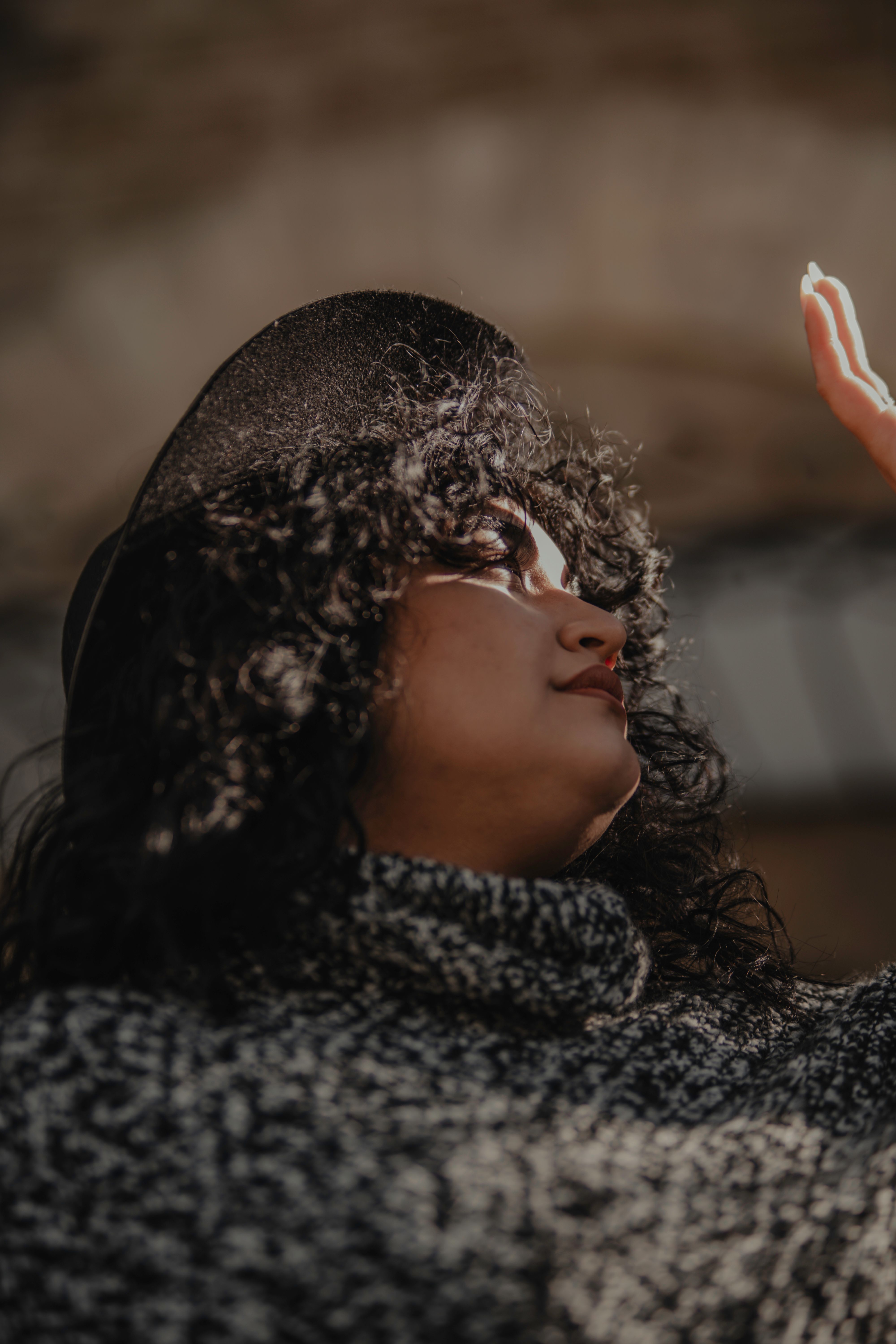 Woman Shielding her Face from the Sun · Free Stock Photo