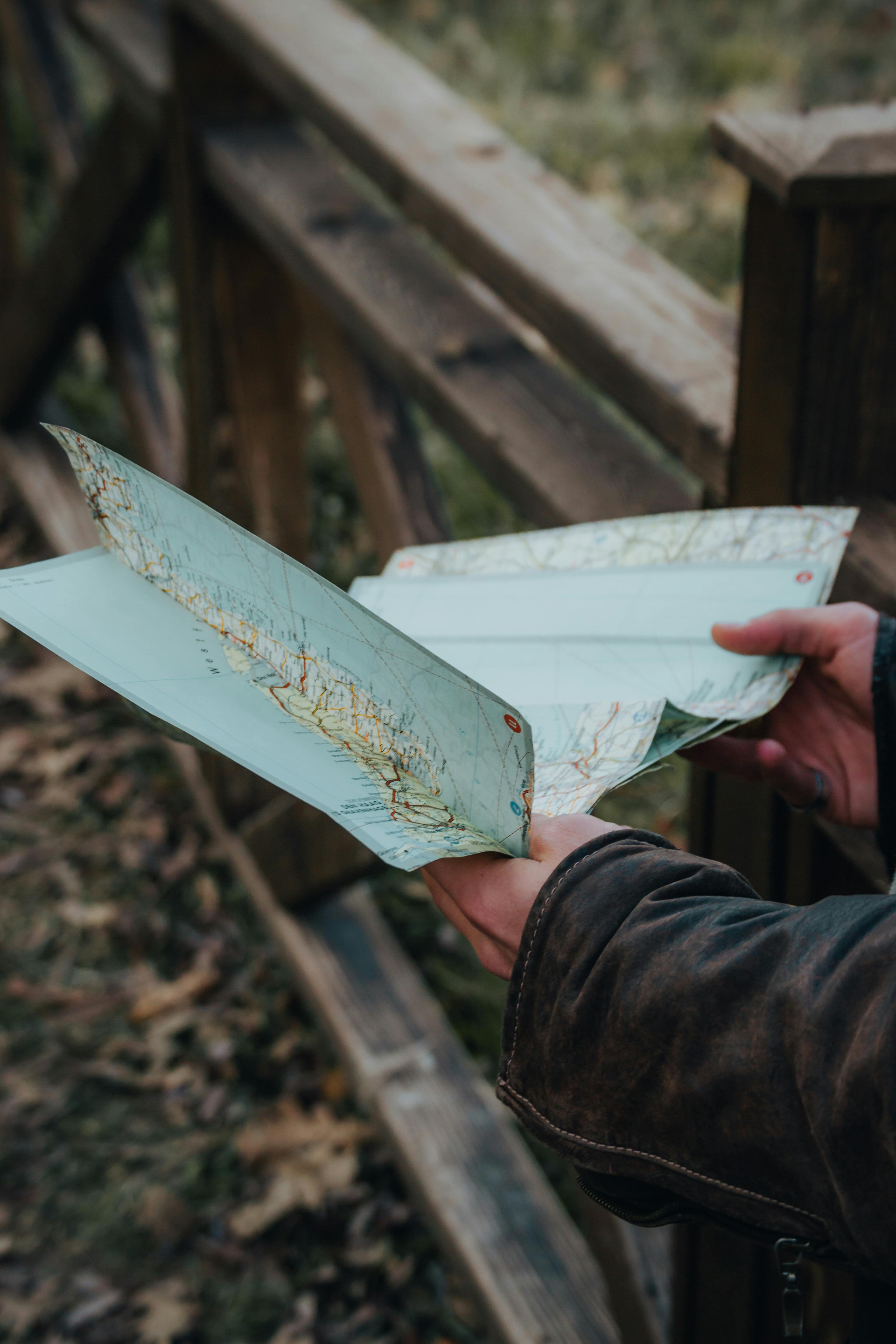 A person holding a map in their hand · Free Stock Photo