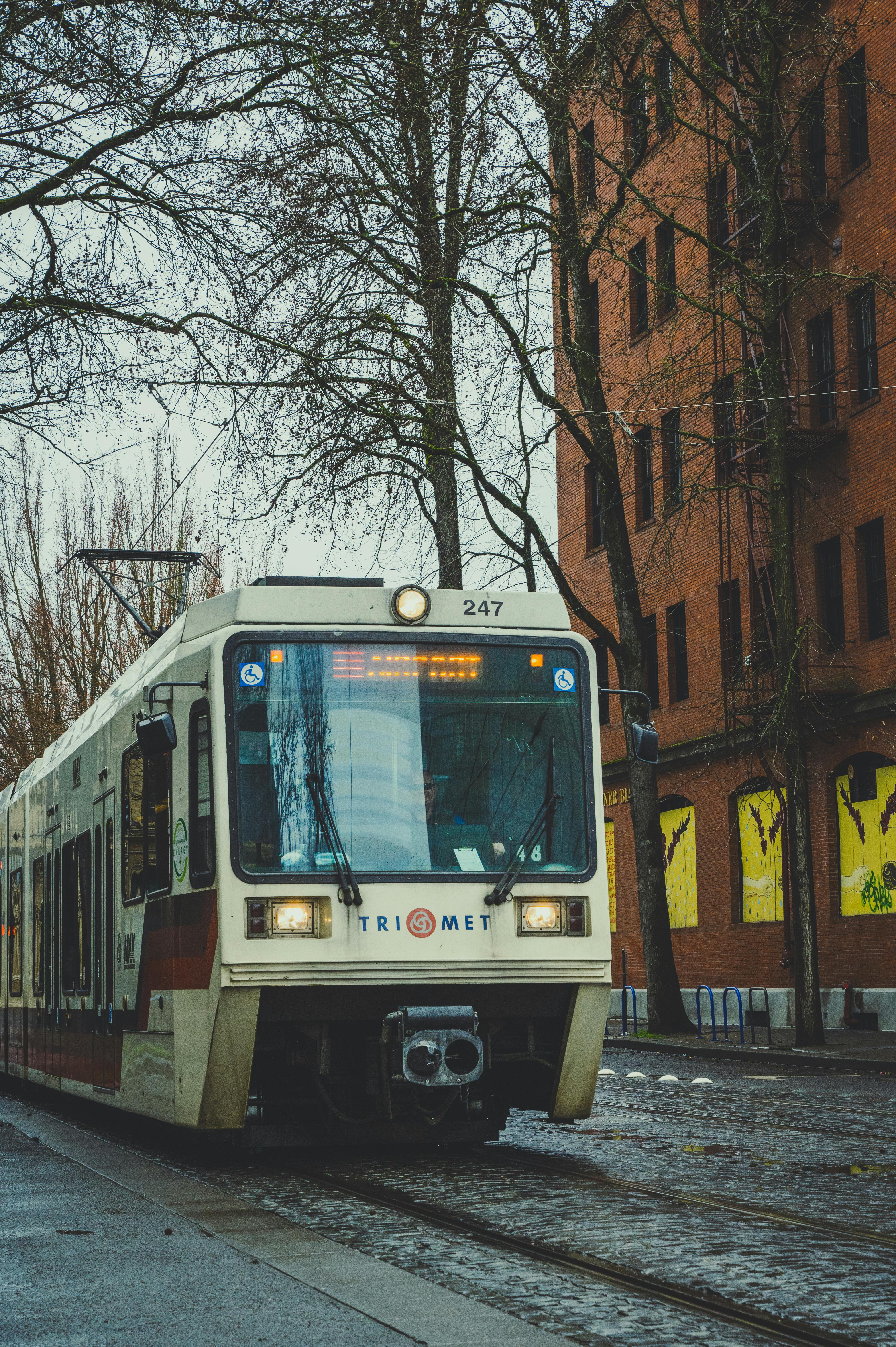 Man Riding on Red and Beige Train · Free Stock Photo