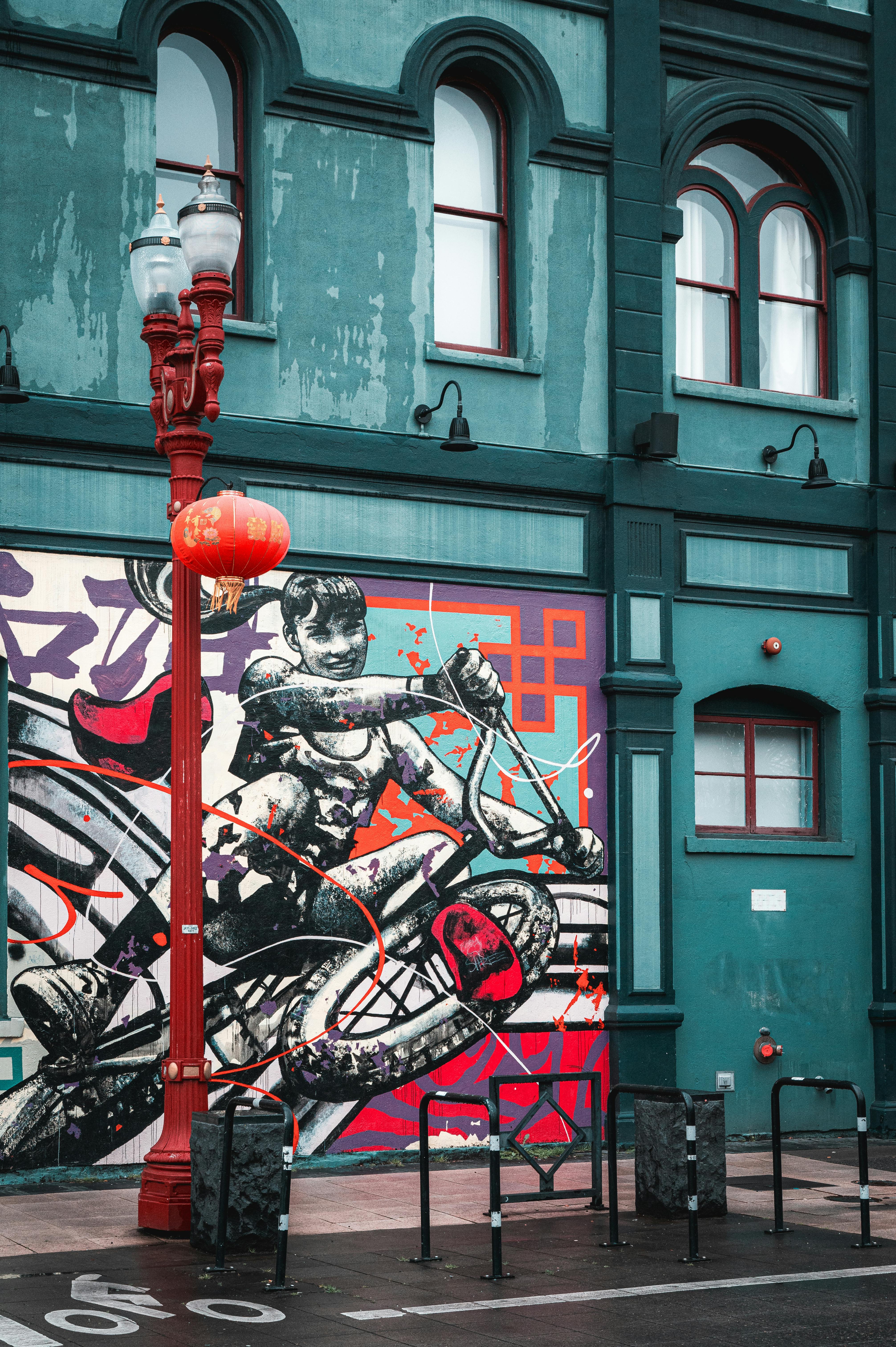 A red lamp post with a bike on it · Free Stock Photo