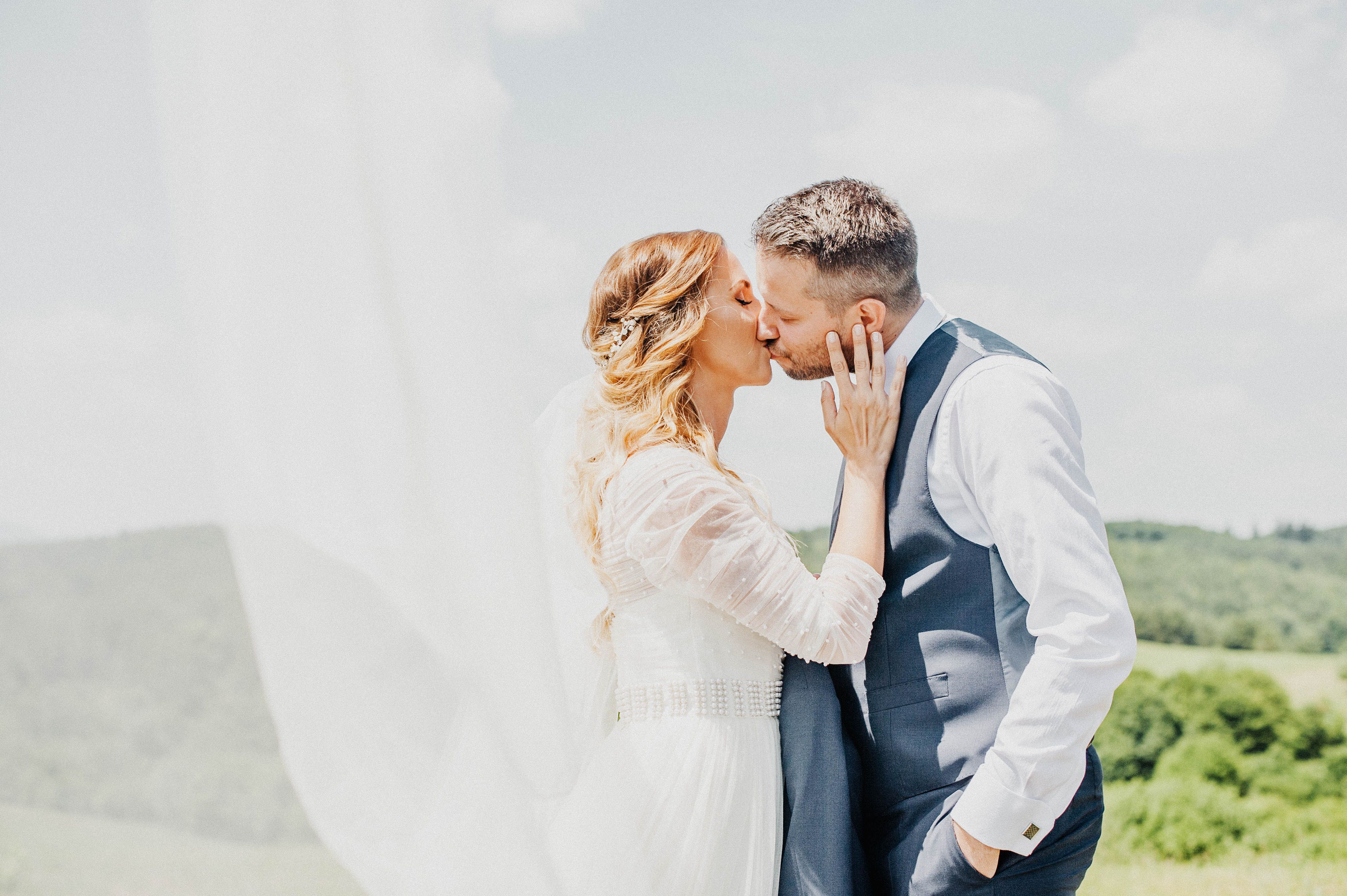 Wedding Couple Kissing by the Lake · Free Stock Photo