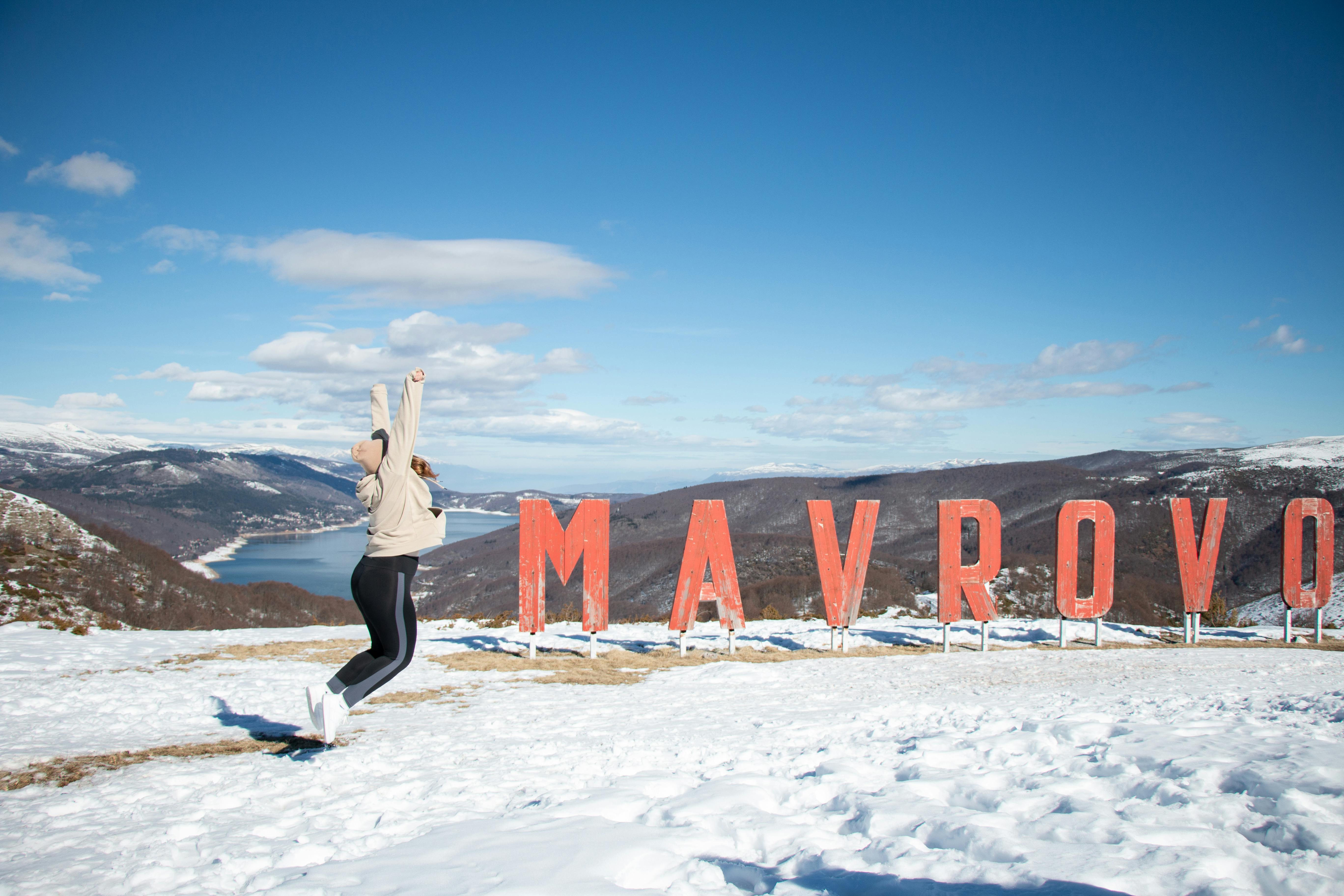 A person jumping in the air in front of a sign that says mavrov · Free ...