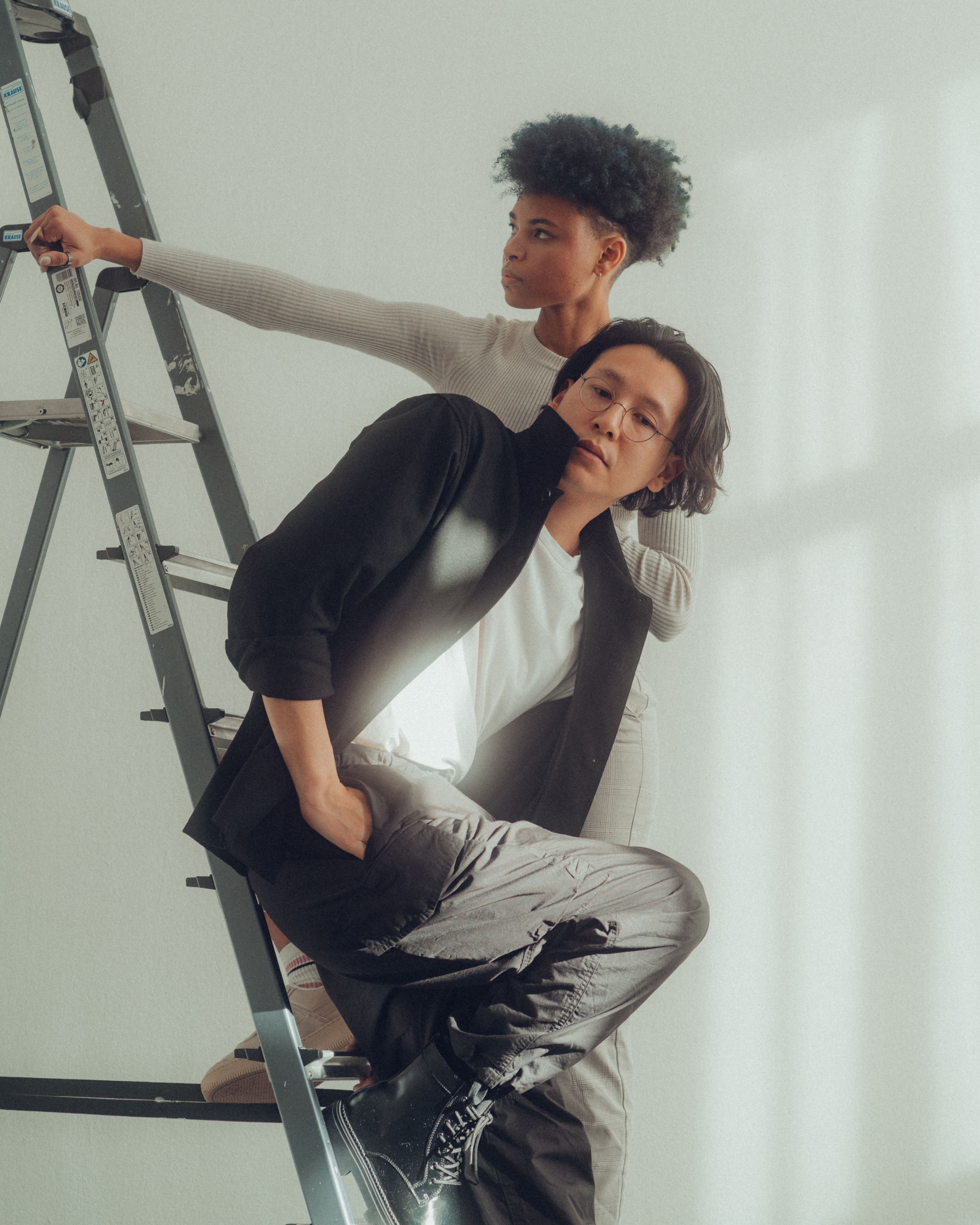 A Man and Woman Posing on a Ladder · Free Stock Photo