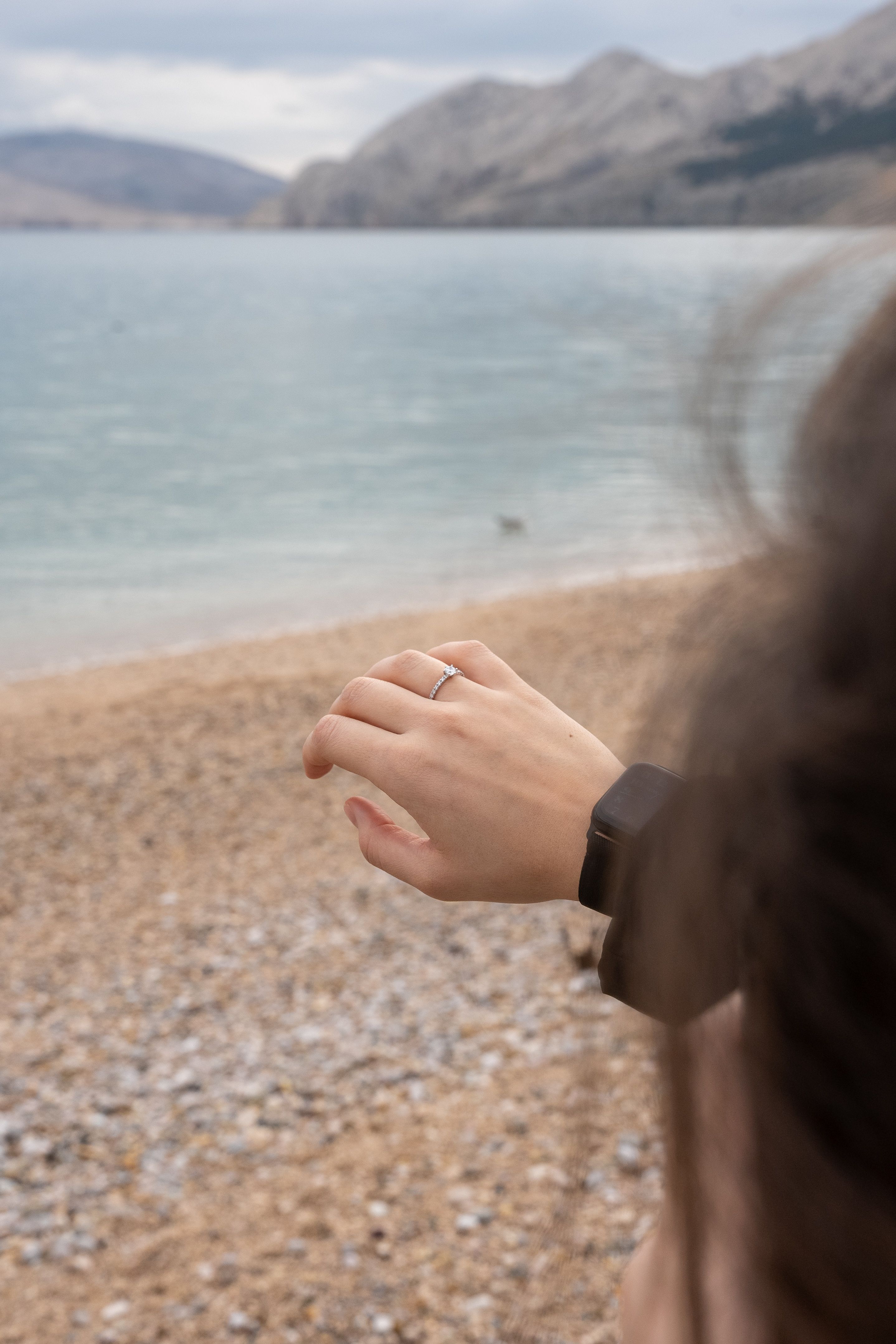 Woman Hand with Ring over Beach · Free Stock Photo
