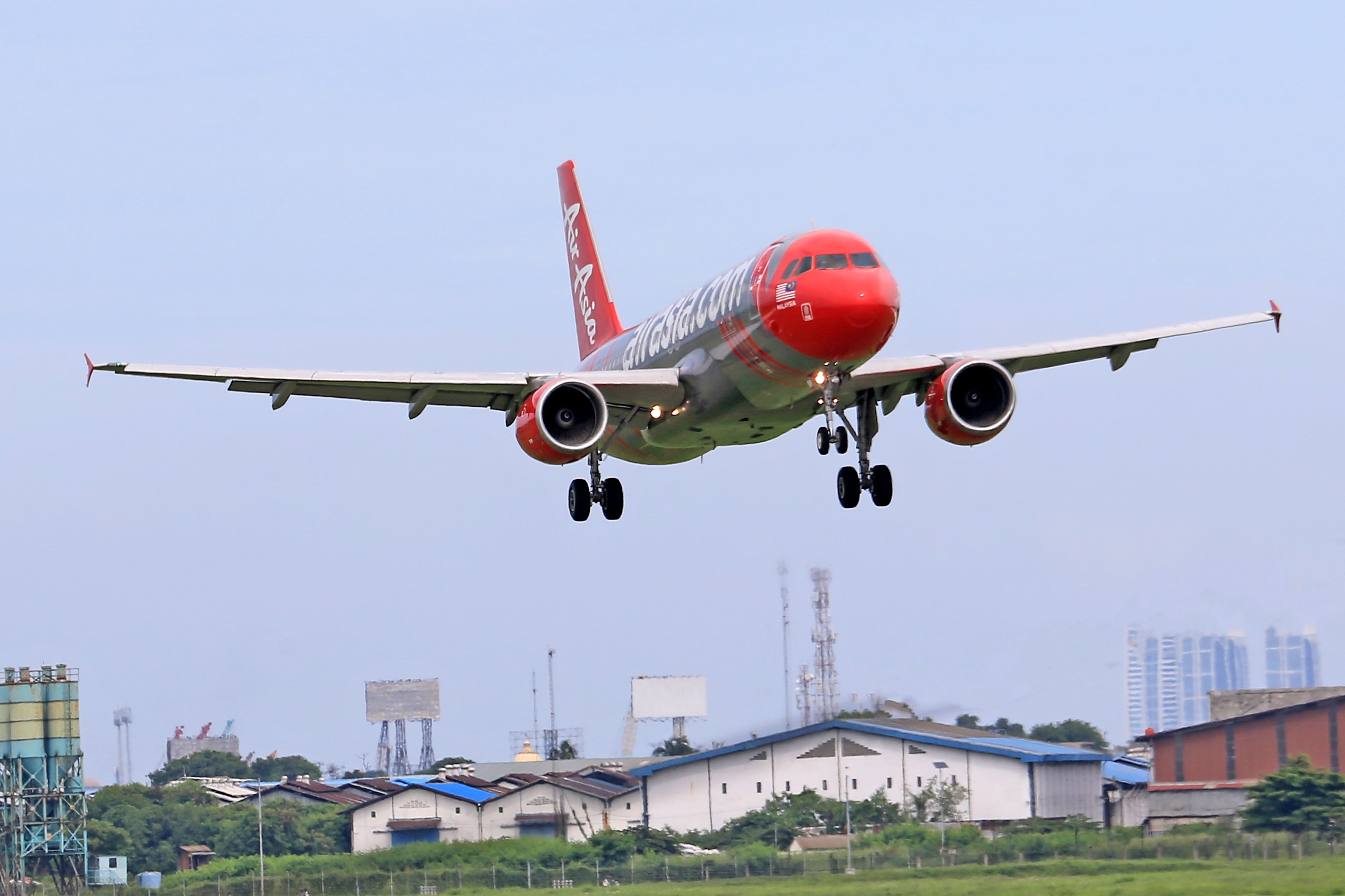 Photo of an AirAsia Airliner Flying Low near the Airport · Free Stock Photo