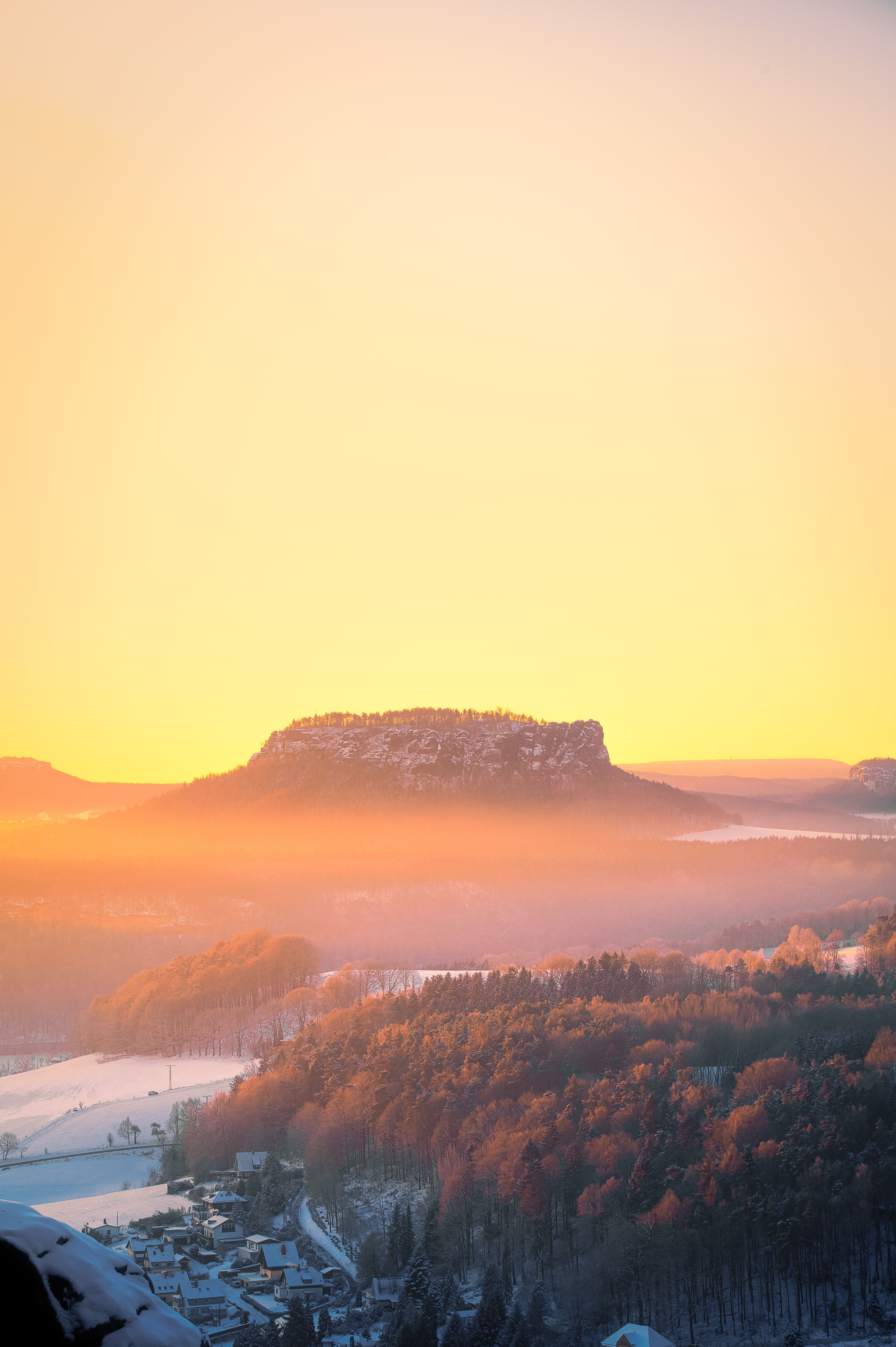 Clear, Yellow Sky over Hill and Forest in Winter · Free Stock Photo
