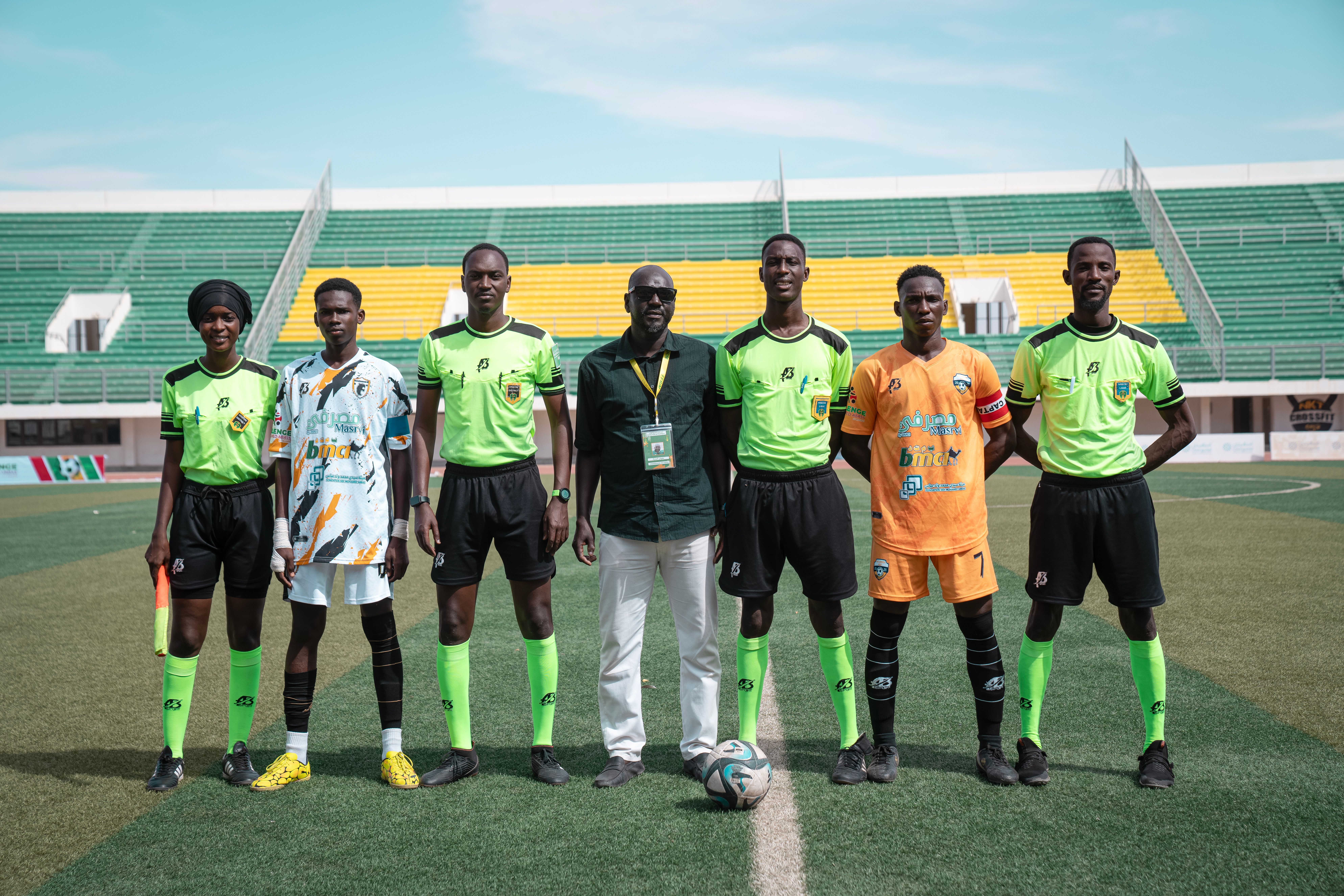 Group of Men on a Football Field · Free Stock Photo