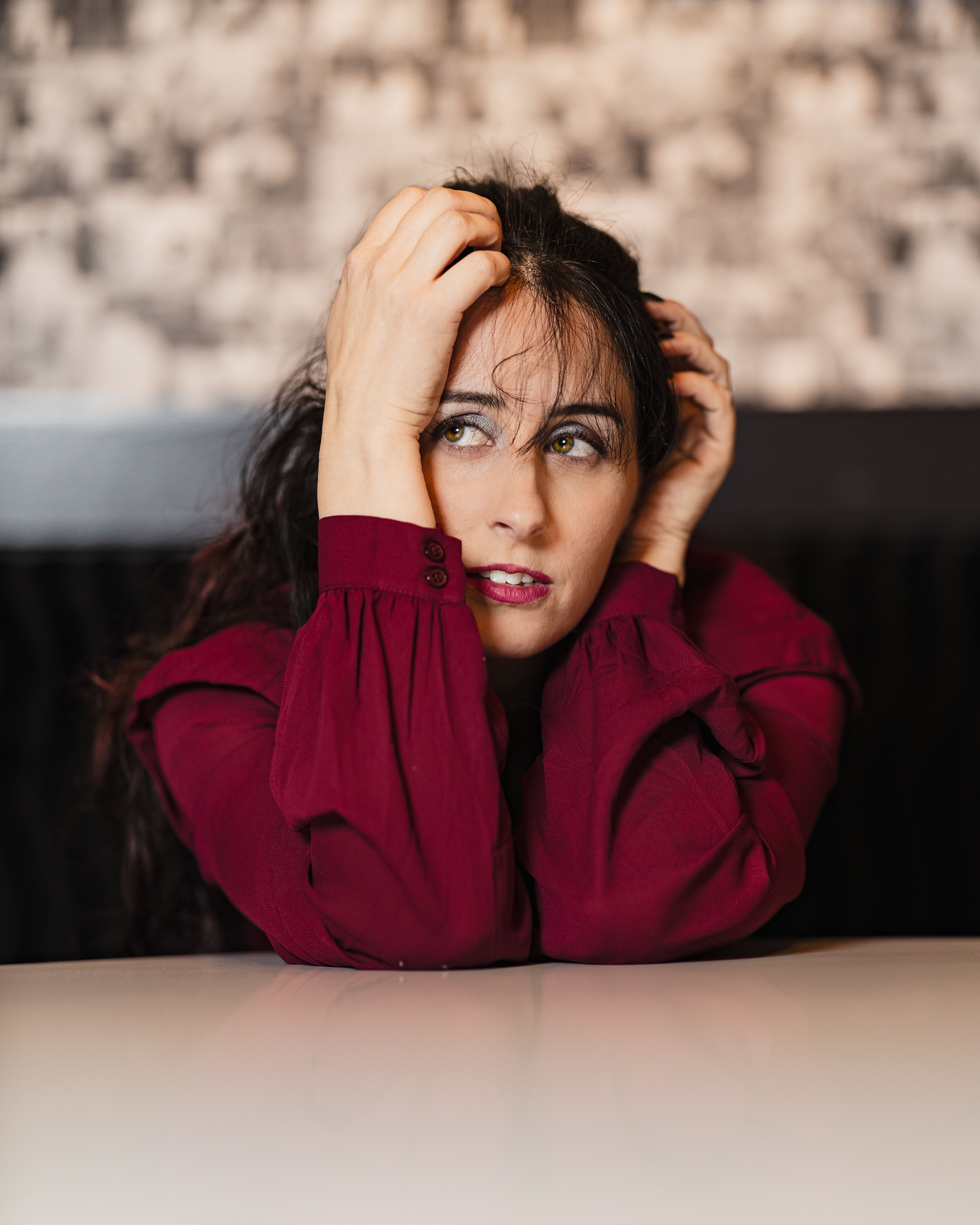 Woman in Red Blouse Tousling Hair · Free Stock Photo