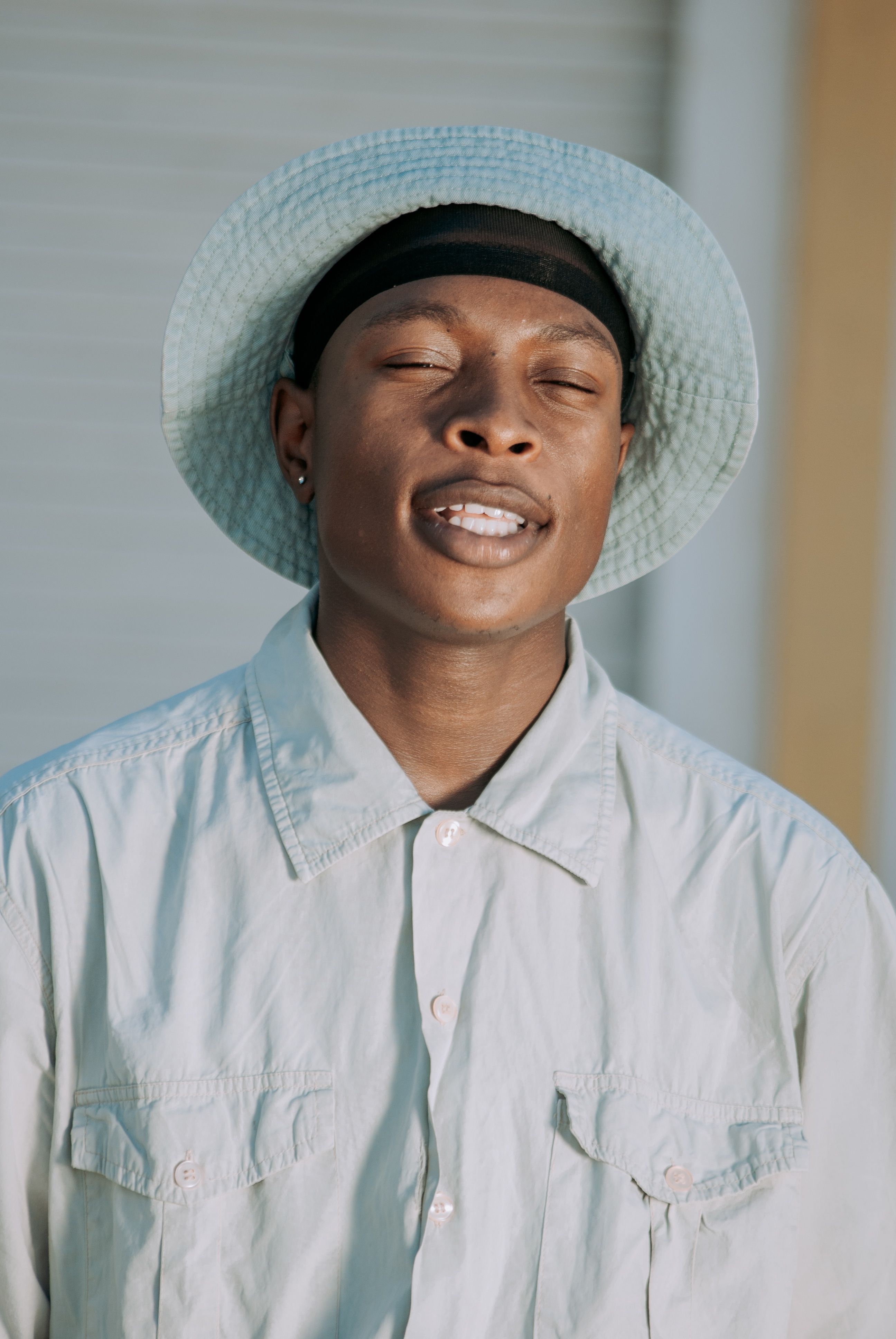 Smiling Man in Shirt and Bucket Hat · Free Stock Photo