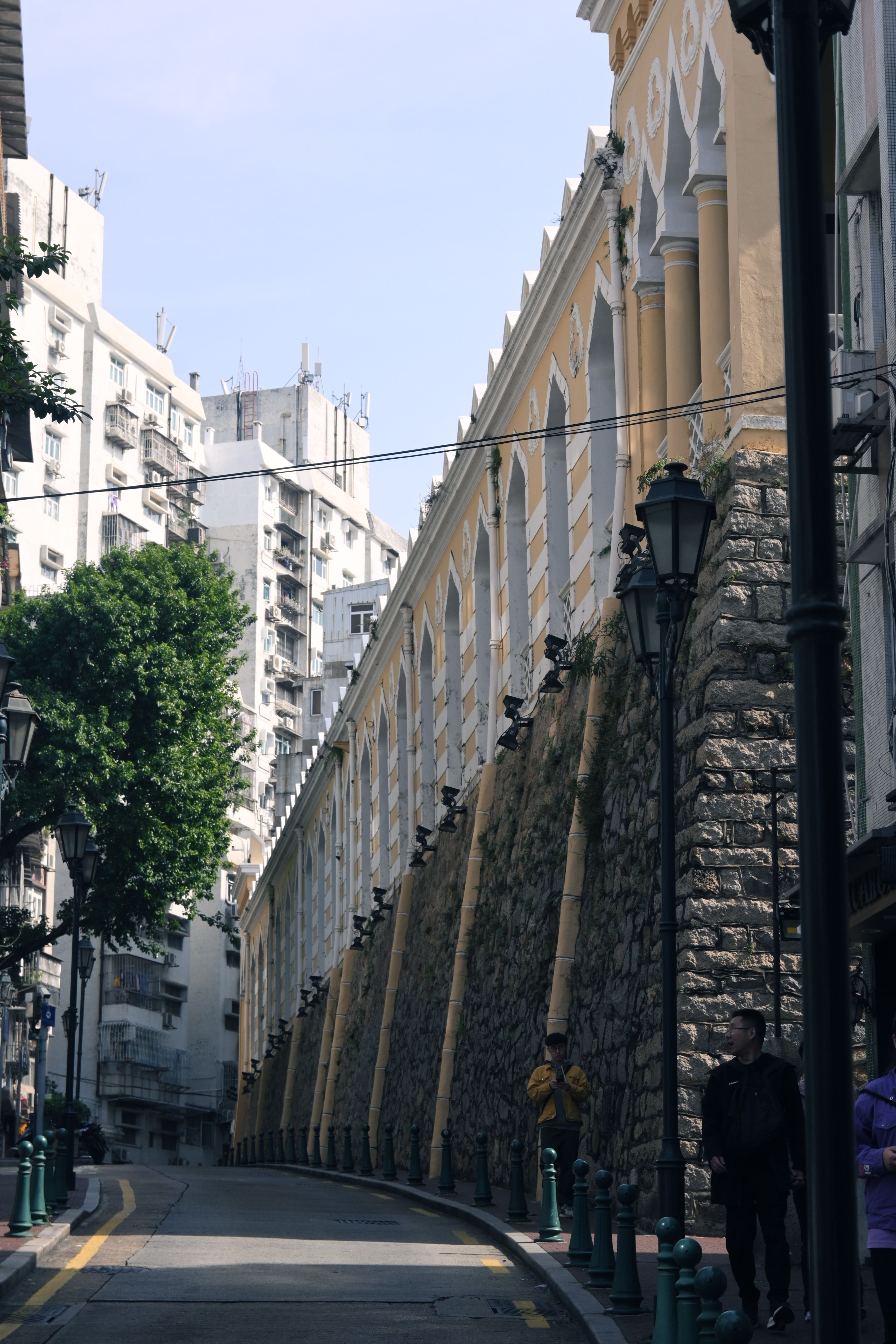 Buildings and Wall over Street in City · Free Stock Photo