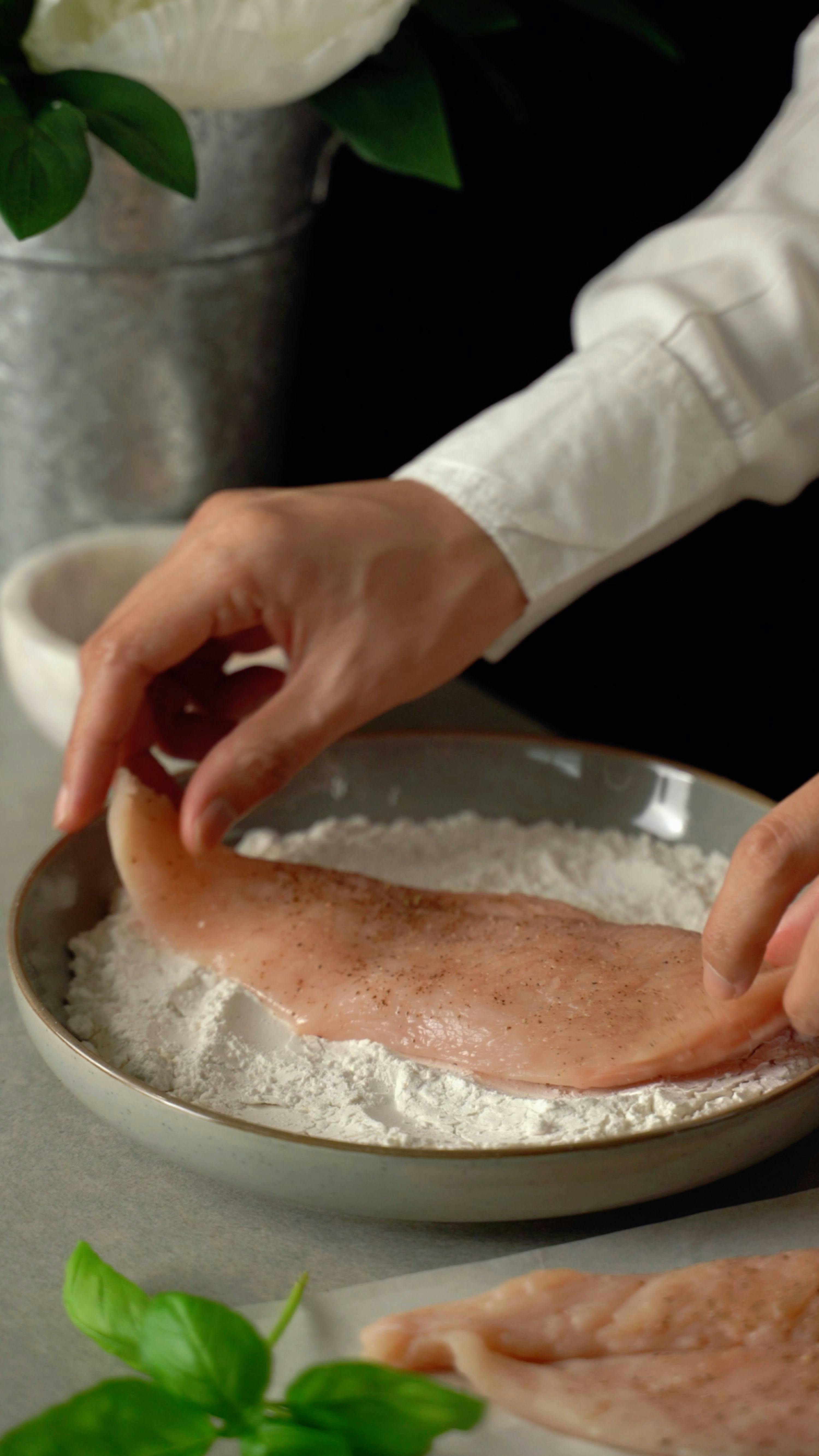 Hands of a Cook Coating Chicken Fillets in Flour · Free Stock Photo