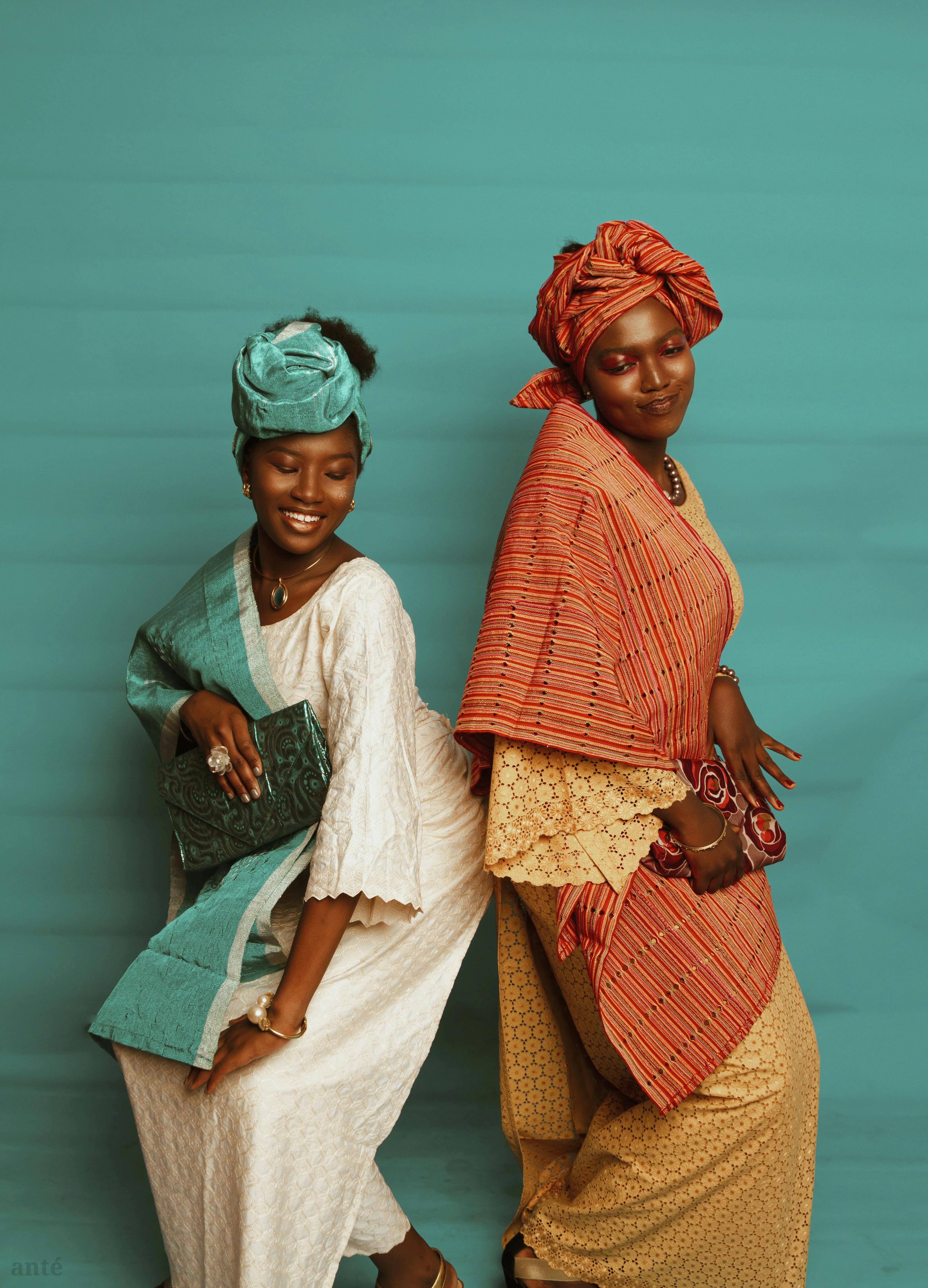 Two Elegant Women in Maxi Dresses and Headscarves Posing in a Studio ...