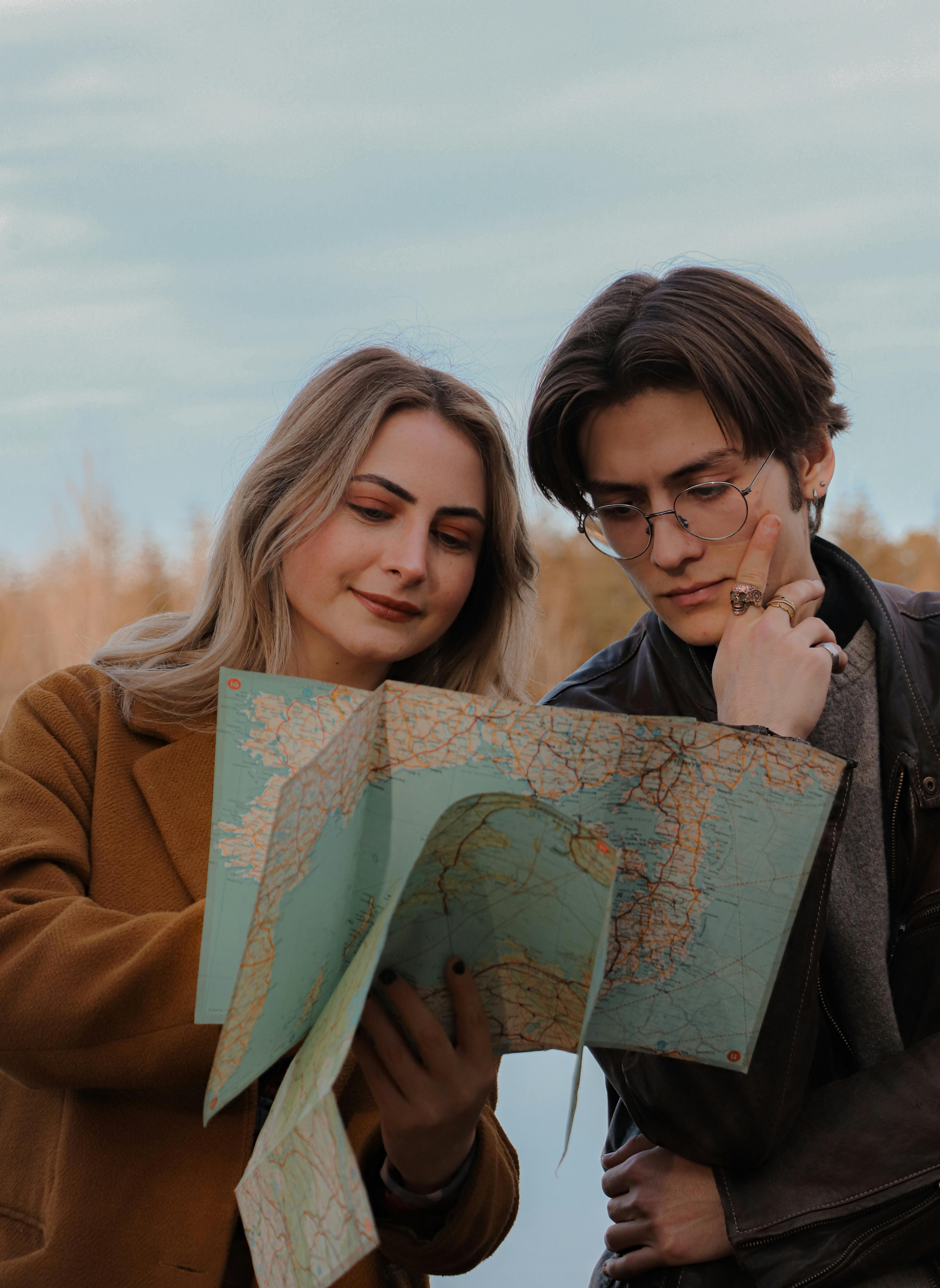 Two people looking at a map together · Free Stock Photo