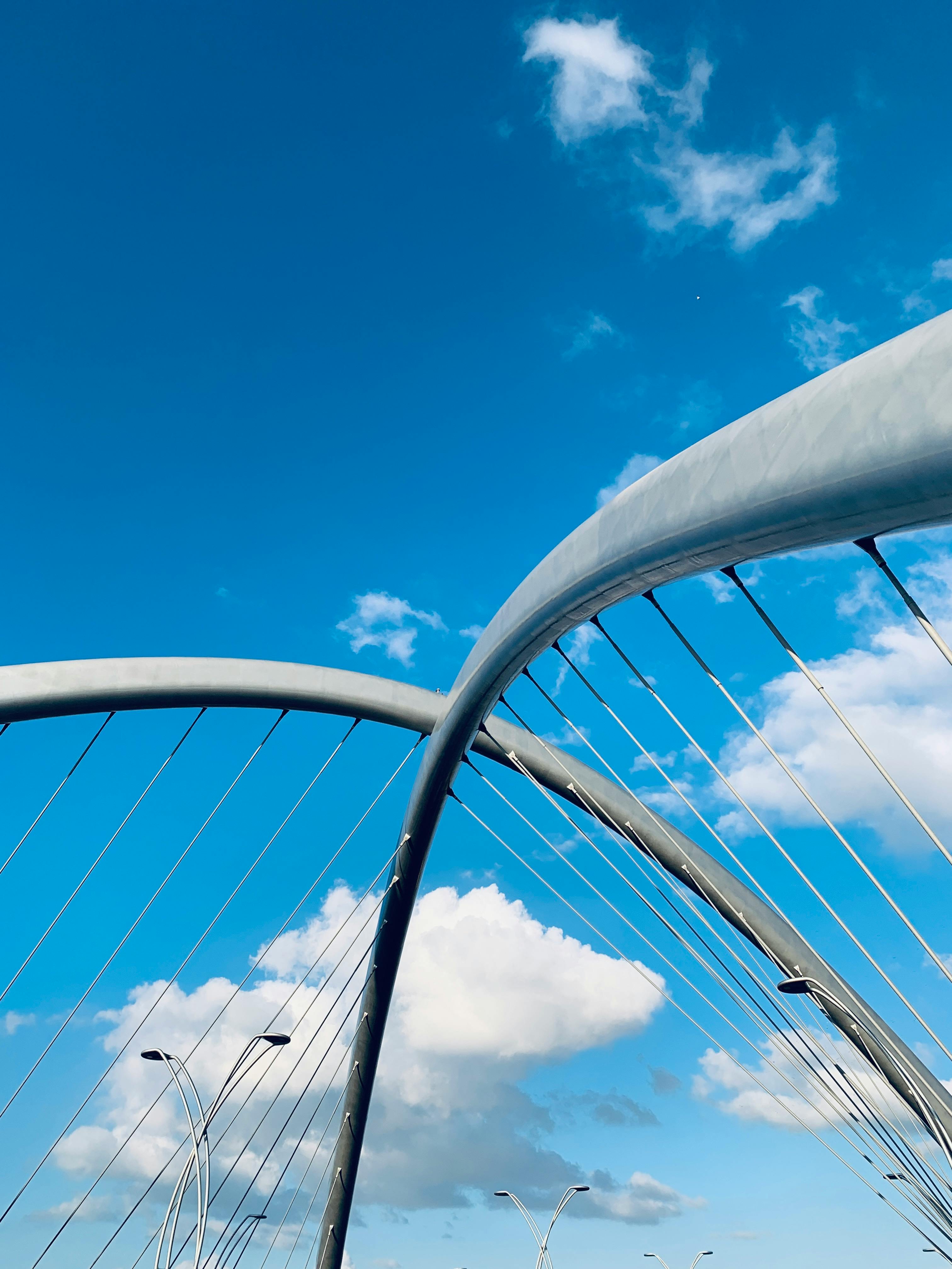 Low Angle Shot of the Top of a Bridge under Blue Sky · Free Stock Photo