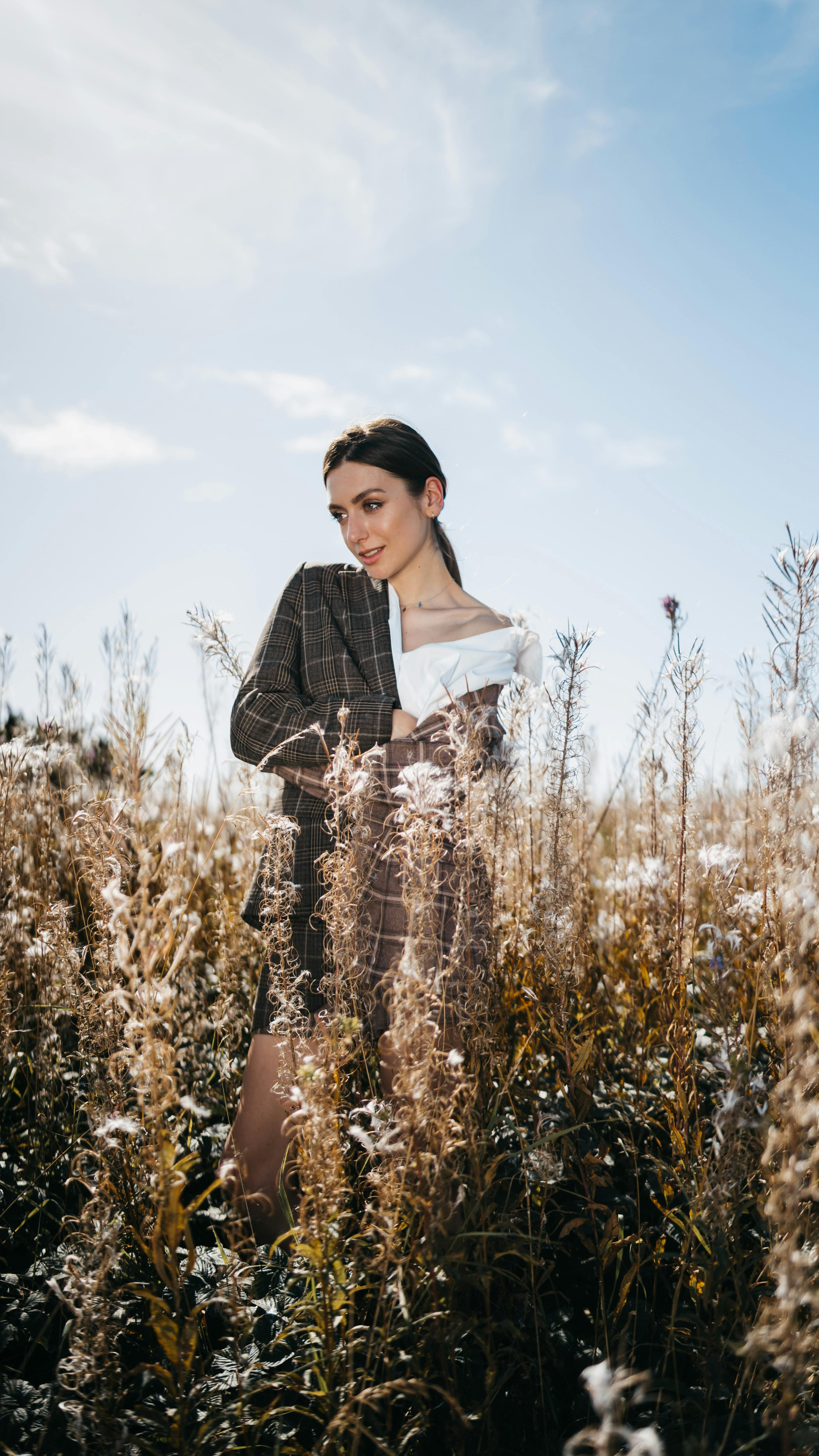 Young Woman Posing in a Field with Dry Grass · Free Stock Photo