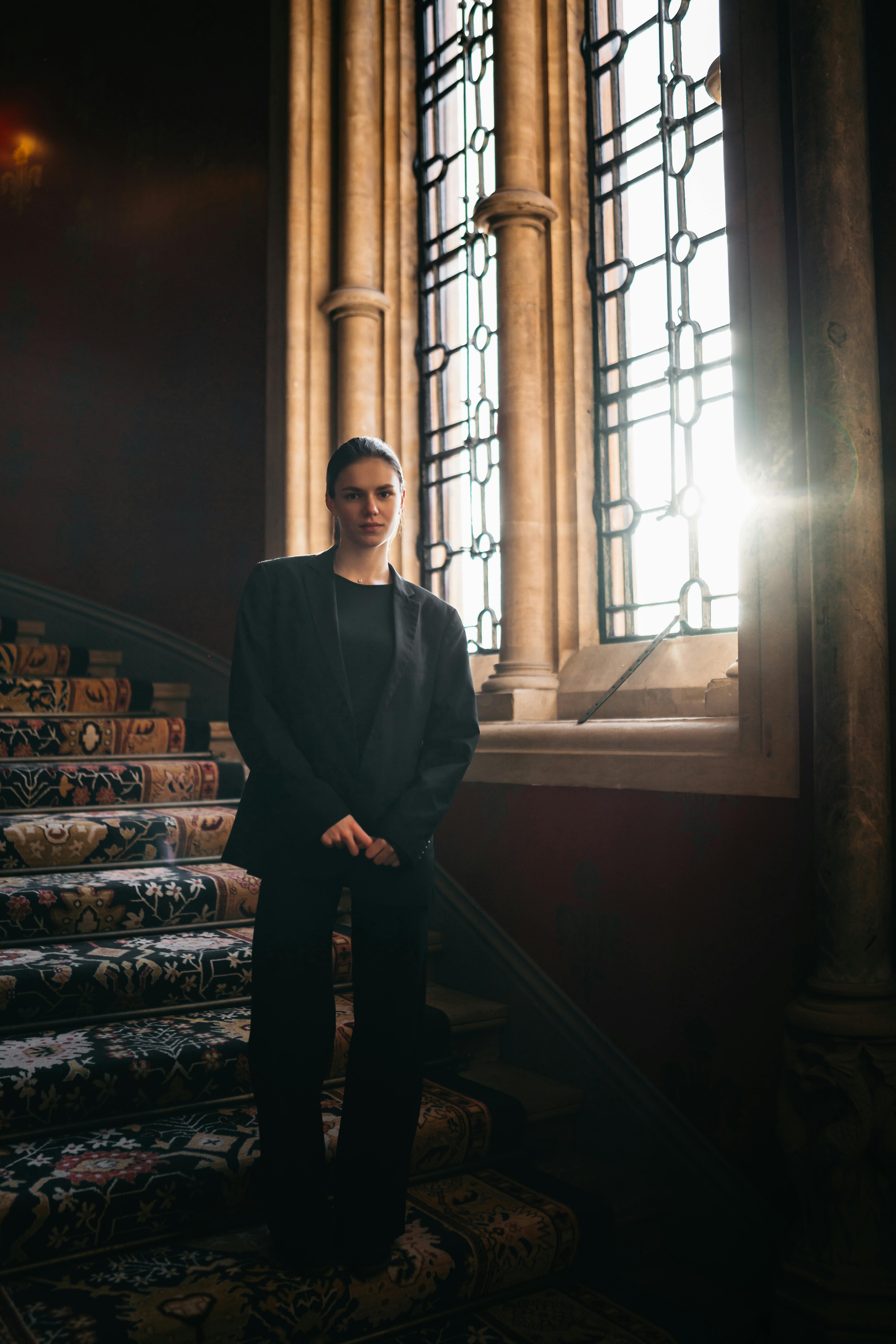 A Woman Standing on a Staircase · Free Stock Photo