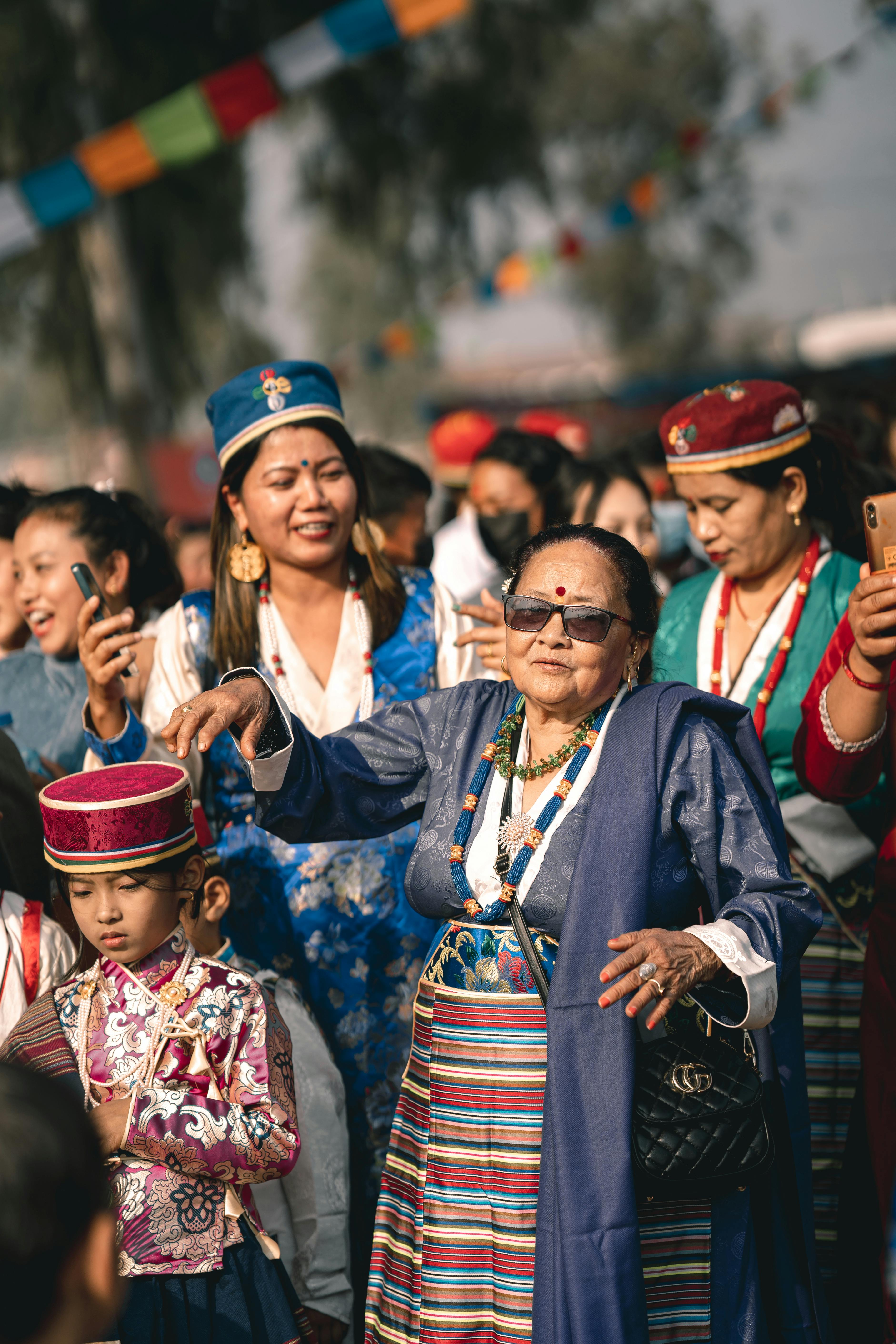 A woman in traditional clothing is surrounded by people · Free Stock Photo