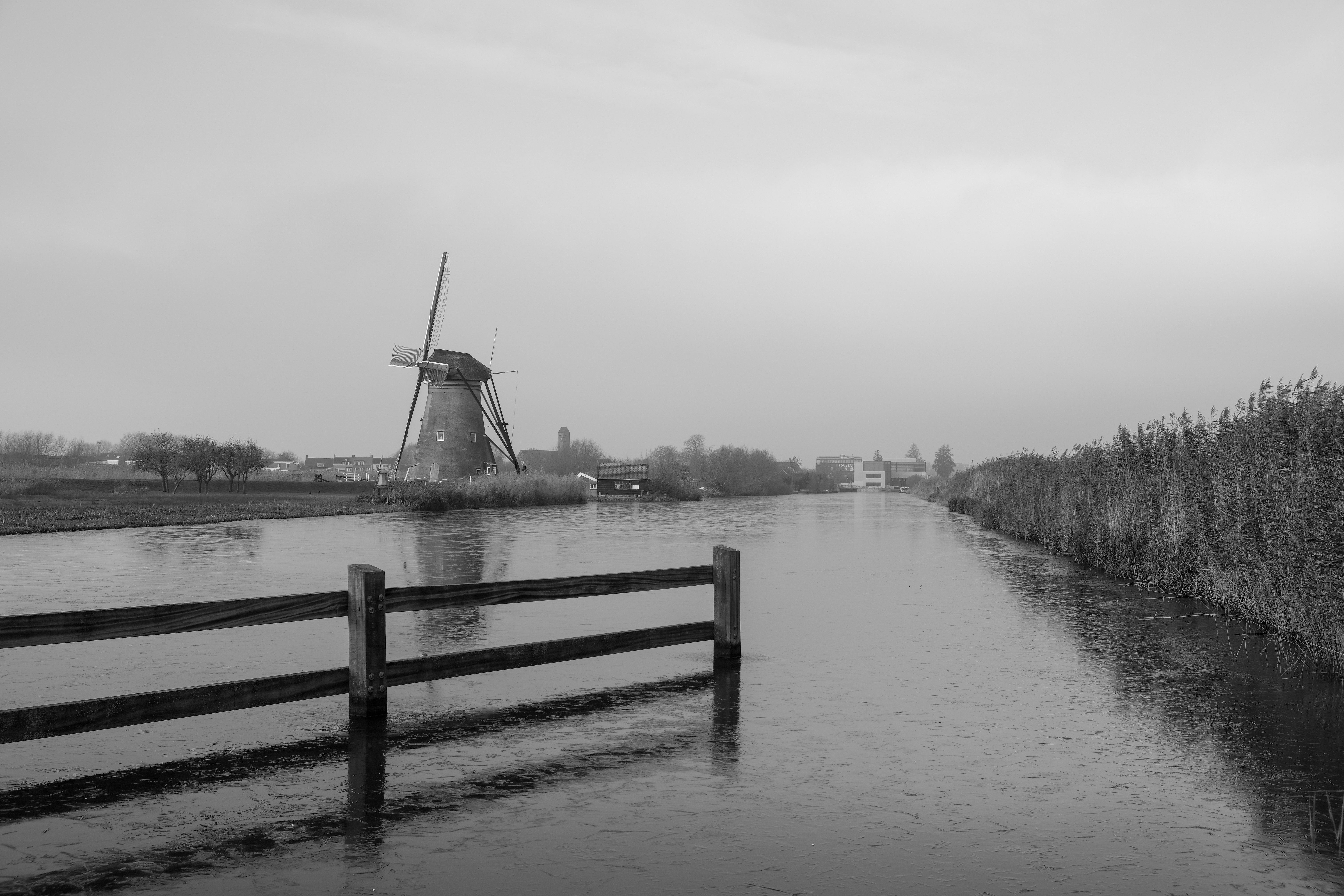 Black and white photo of a windmill in the rain · Free Stock Photo