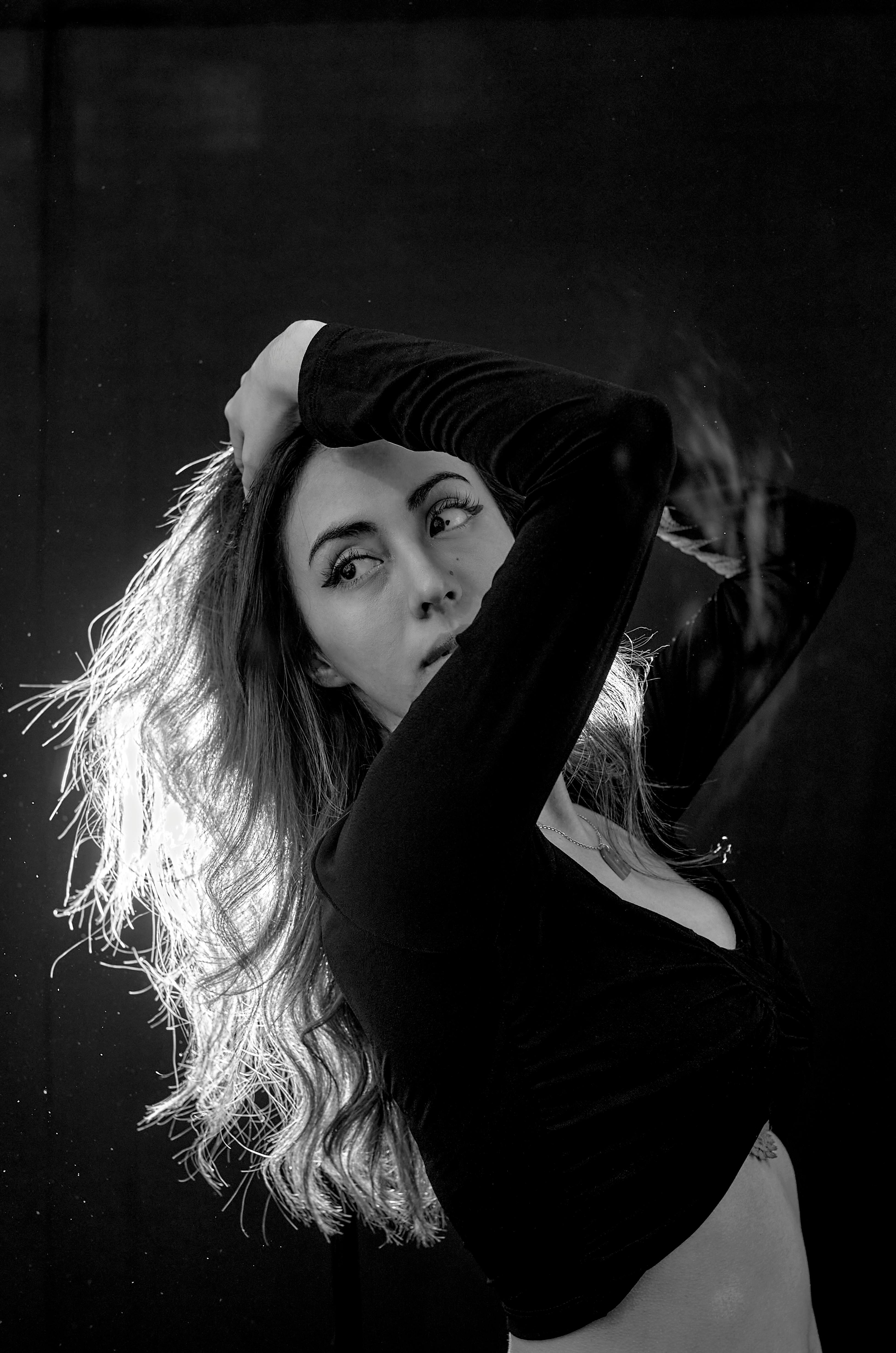 Woman in a Hat and Crop Top Smoking a Cigarette in the Back Alley ...